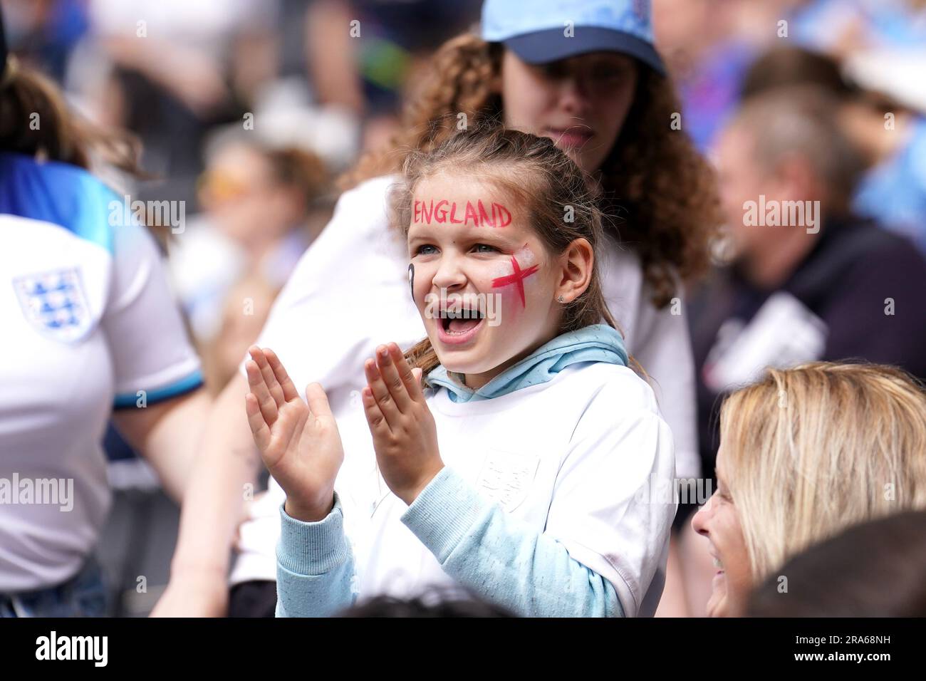 A young England fan cheers the players before a Women's international ...
