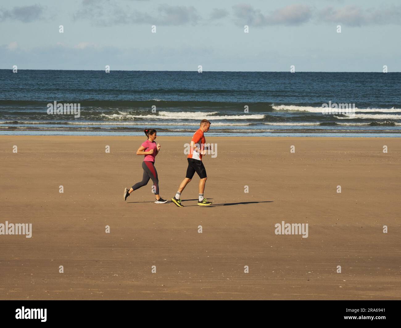 jogging on the beach, Rhossili Bay Beach, Gower Peninsula, Wales Stock ...