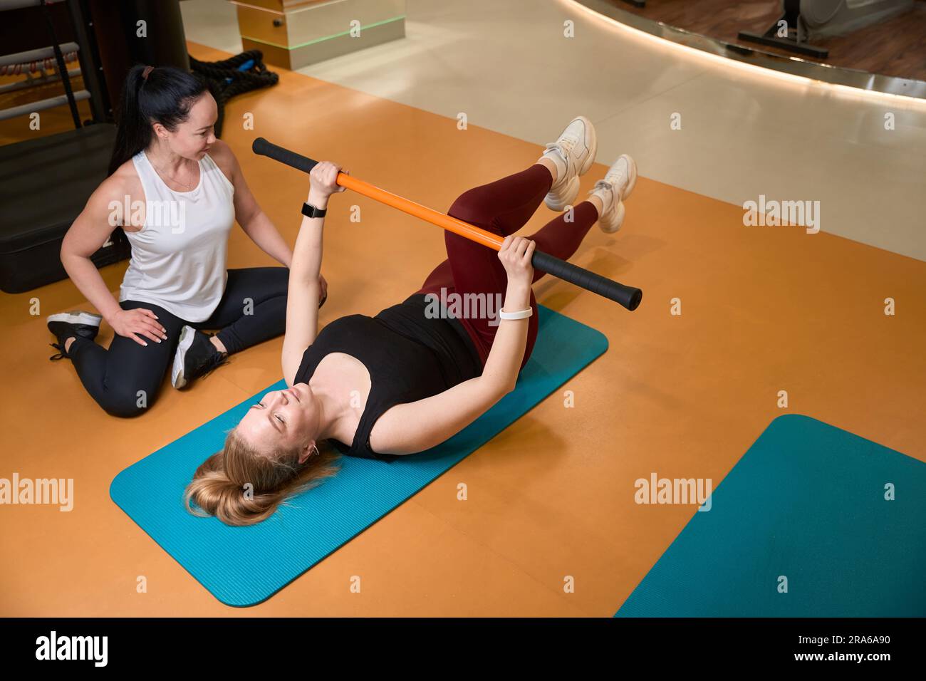 Blonde performs effective exercises with a gymnastic stick Stock Photo ...