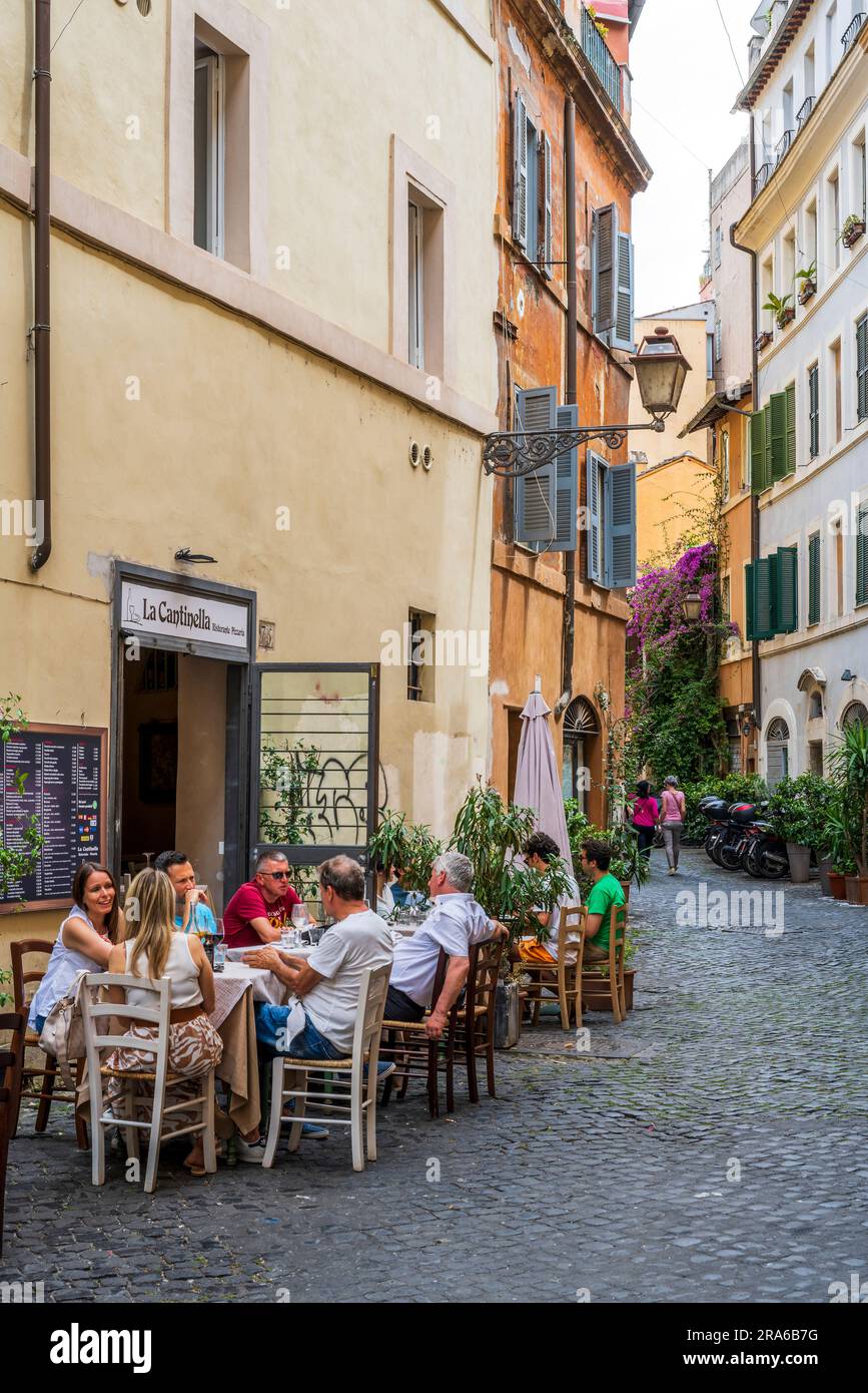 Scenic view of sidewalk cafe restaurant in a cobbled street, Rome ...