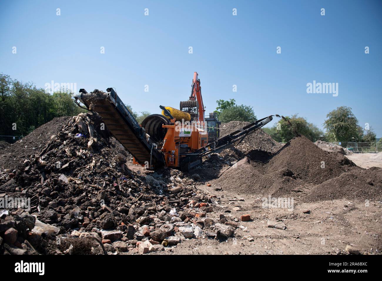 A trommel machine sorting rubble in different piles Stock Photo - Alamy