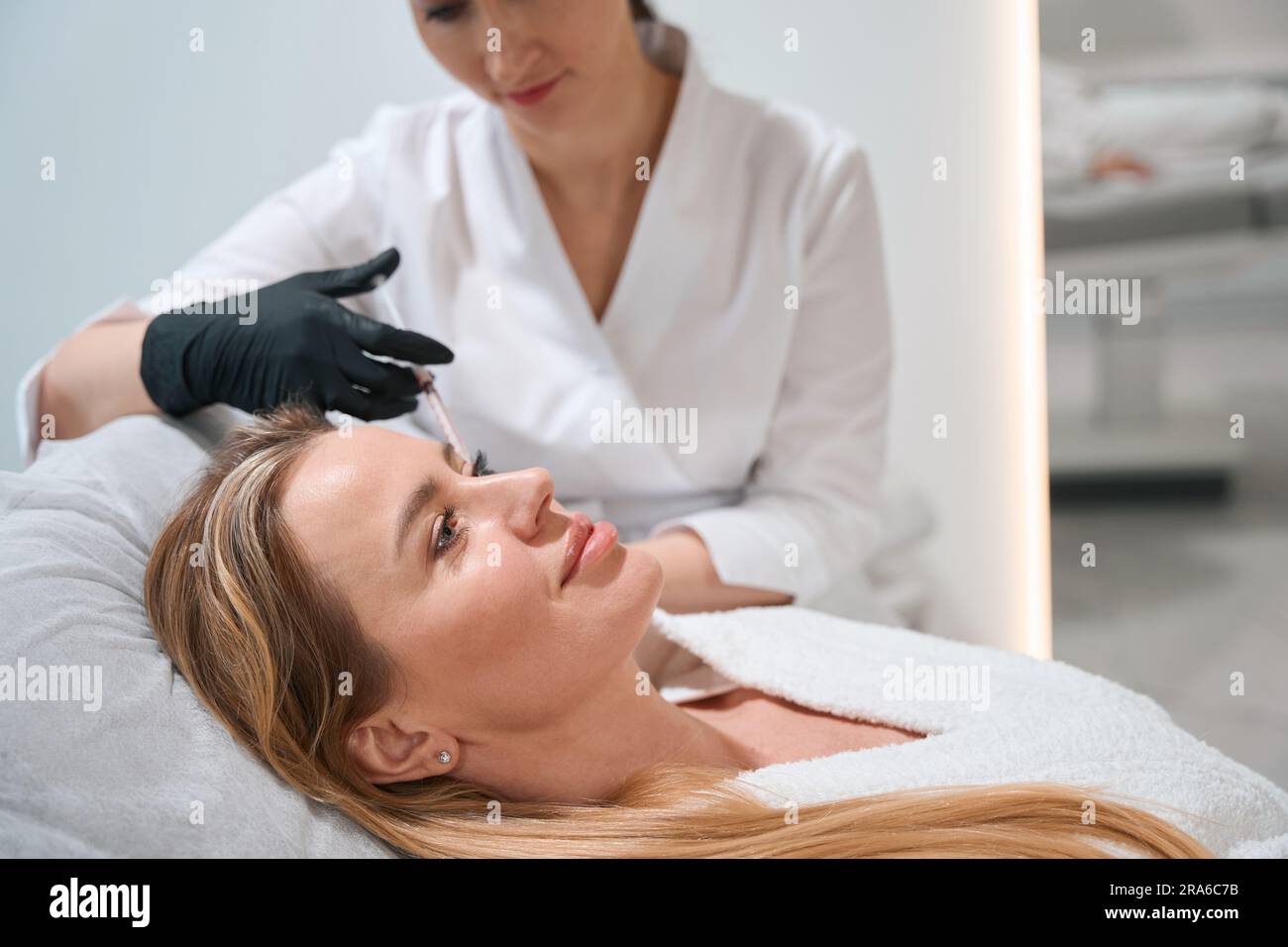 Woman beautician makes rejuvenating facial hi-res stock photography and ...
