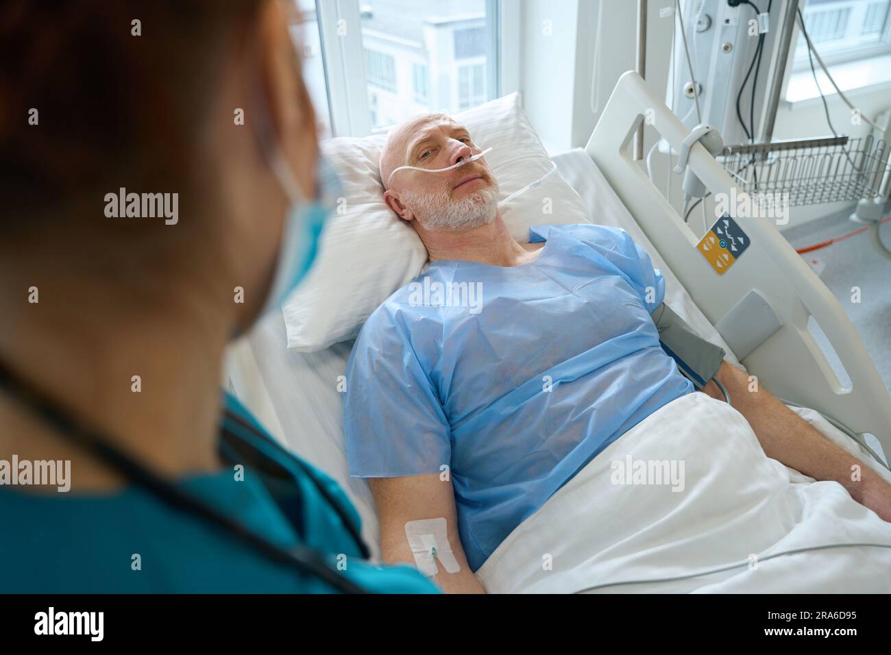 Female medic learning about male patient in the hospital bed Stock ...