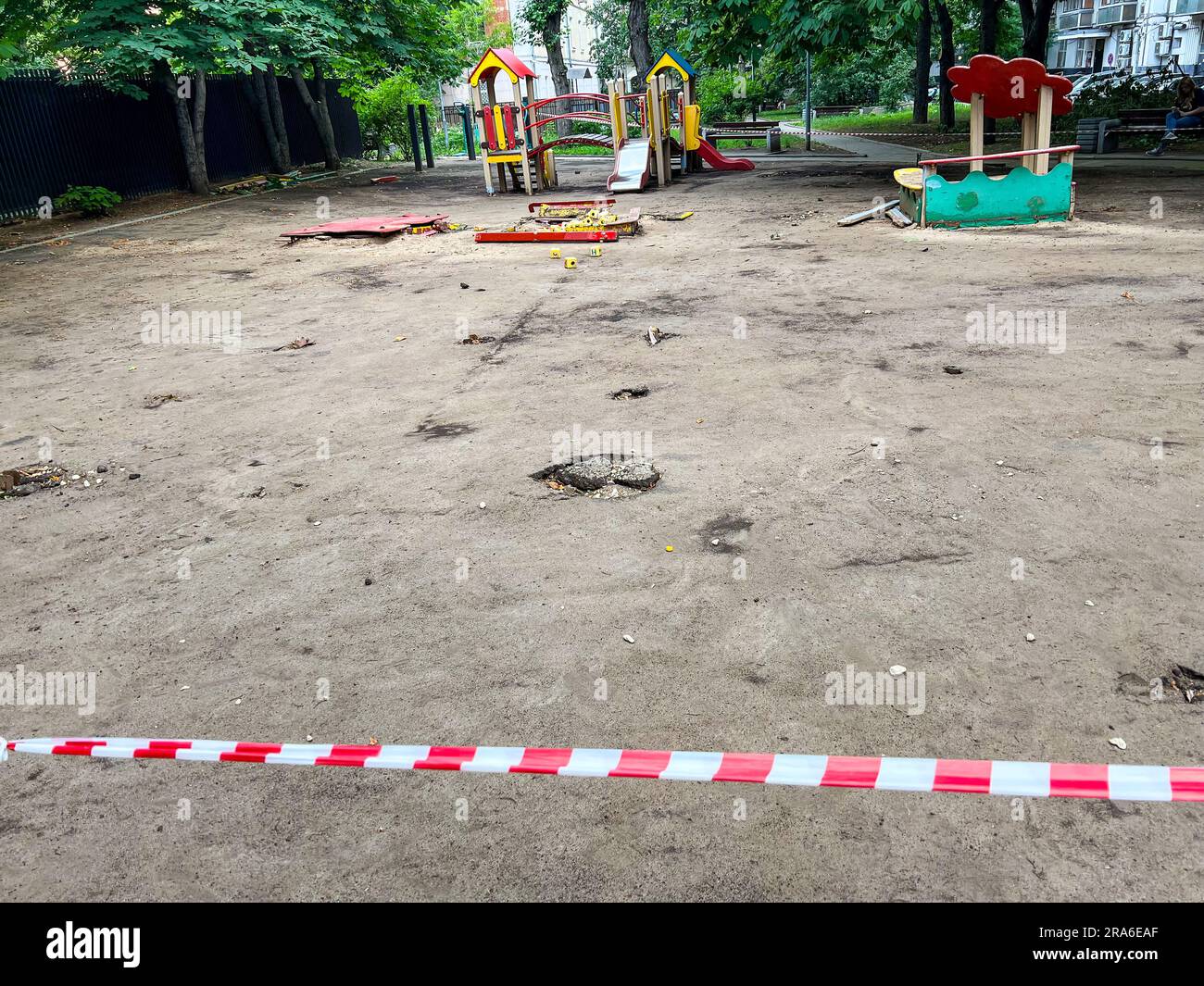A destroyed children playground behind the barrier tape Stock Photo - Alamy