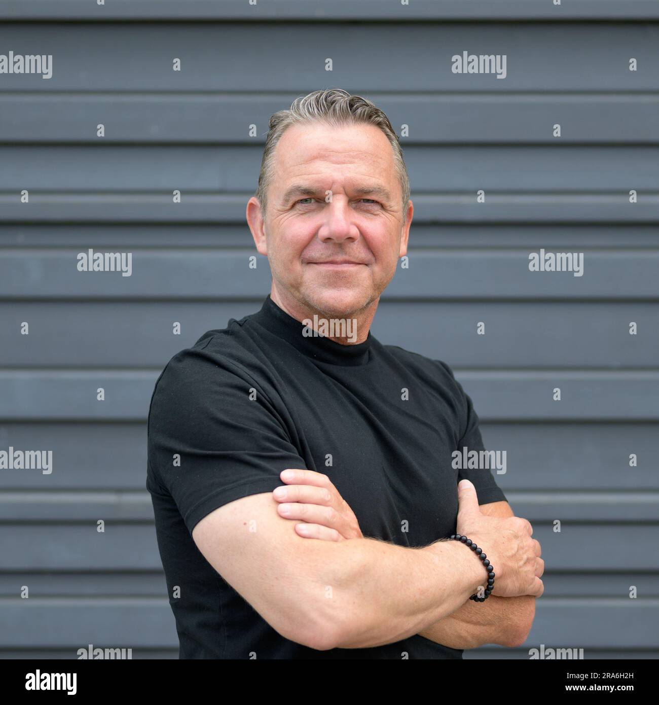 Square portrait of a senior man looking sternly straight ahead at the ...