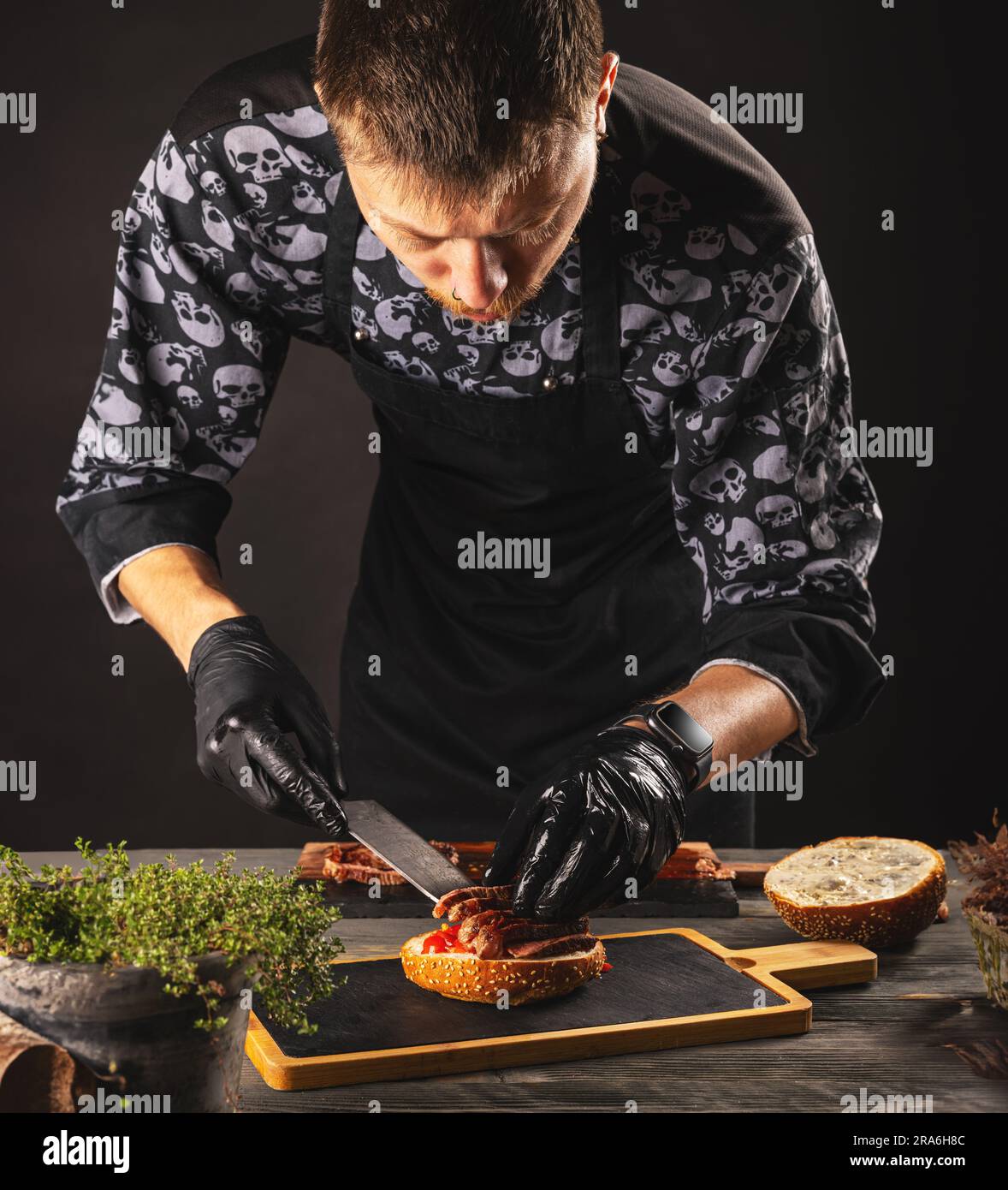 Cooking steak burger concept. Cook preparing steak burger adding meat ...