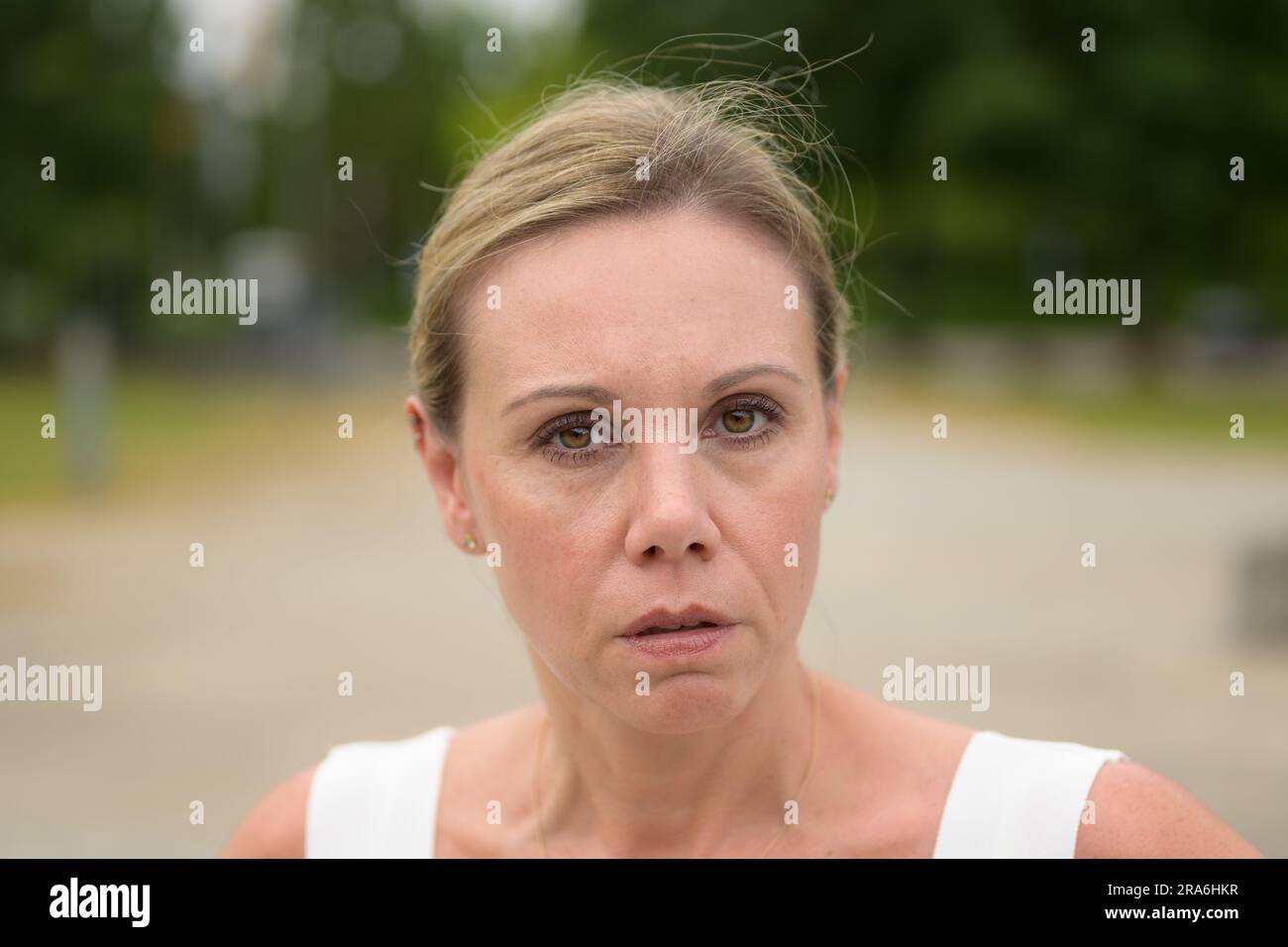 Close-up of an attractive forty year old woman looking annoyed at the ...