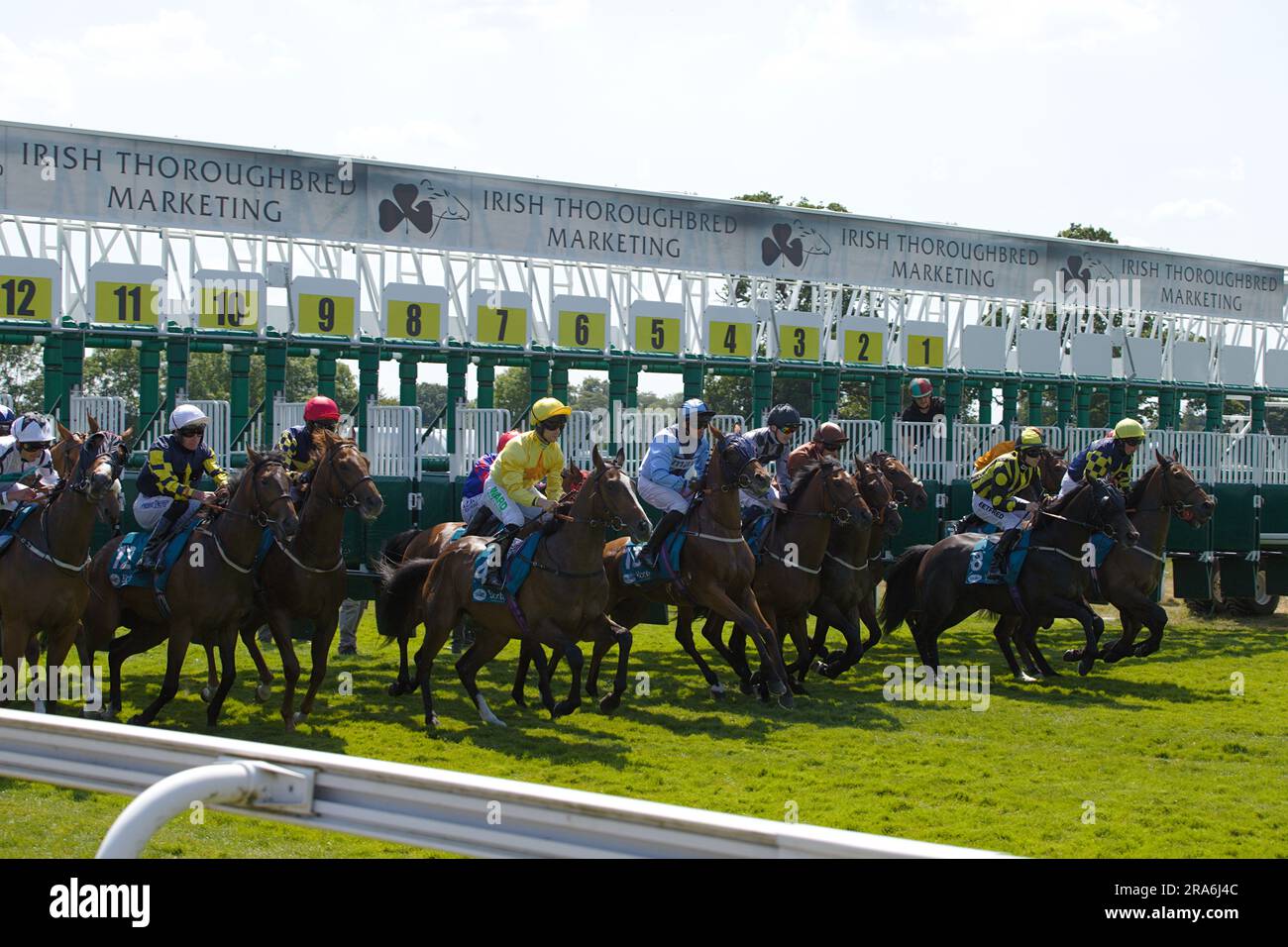 Sequence of jockeys and their horses leaving the starting gates at York ...