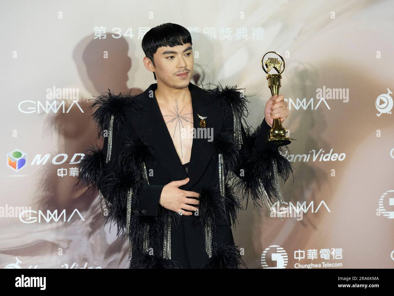 Taiwanese singer Hush holds his award for Best Male Singer (Mandarin ...
