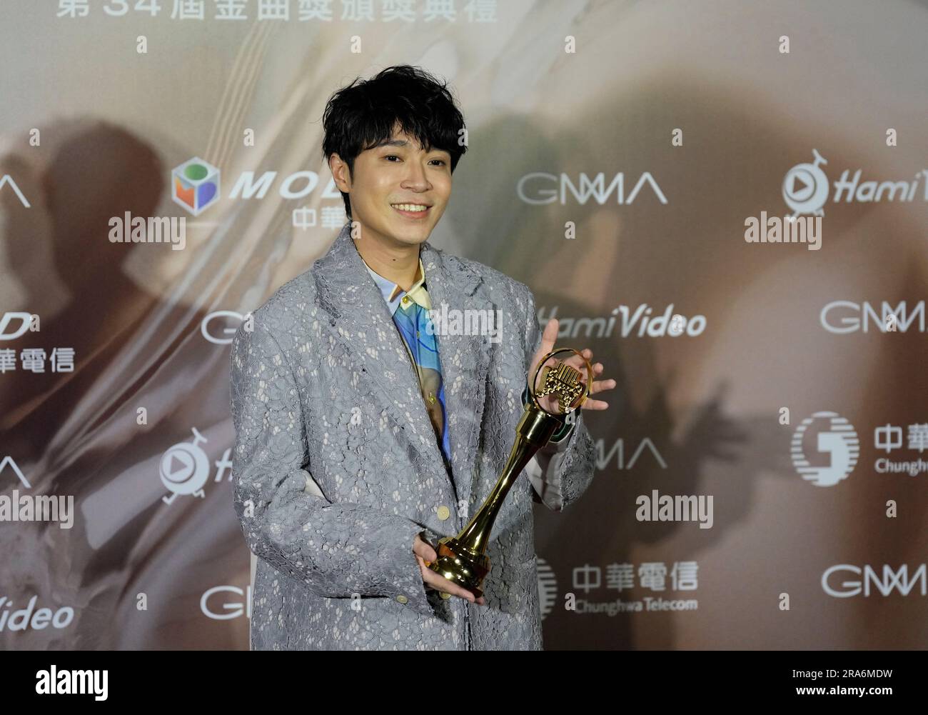 Taiwanese singer Wu Qing Feng holds his awards for Best Mandarin Album ...