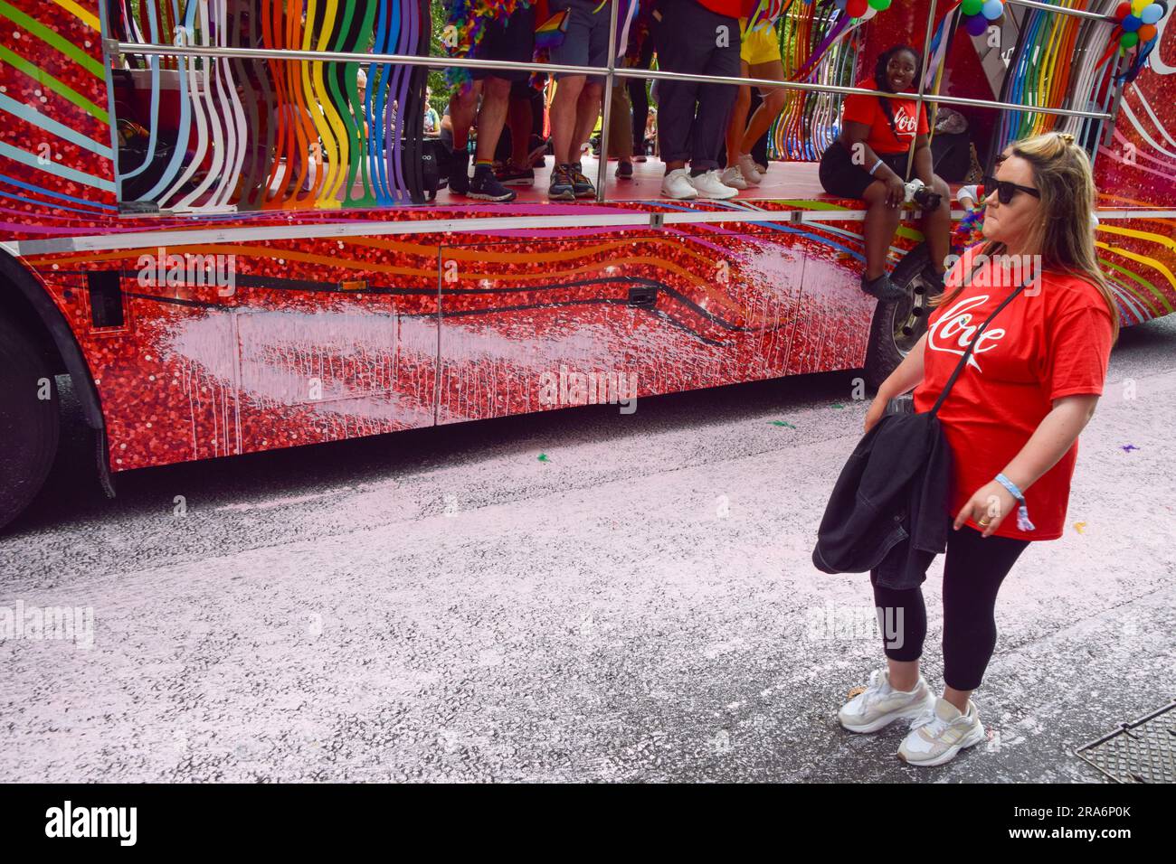 London, UK. 01st July, 2023. A parade participant looks at the pink ...