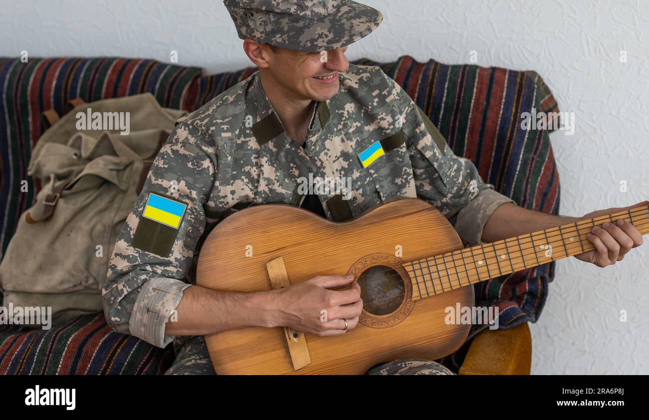Ukrainian military man with a guitar Stock Photo - Alamy