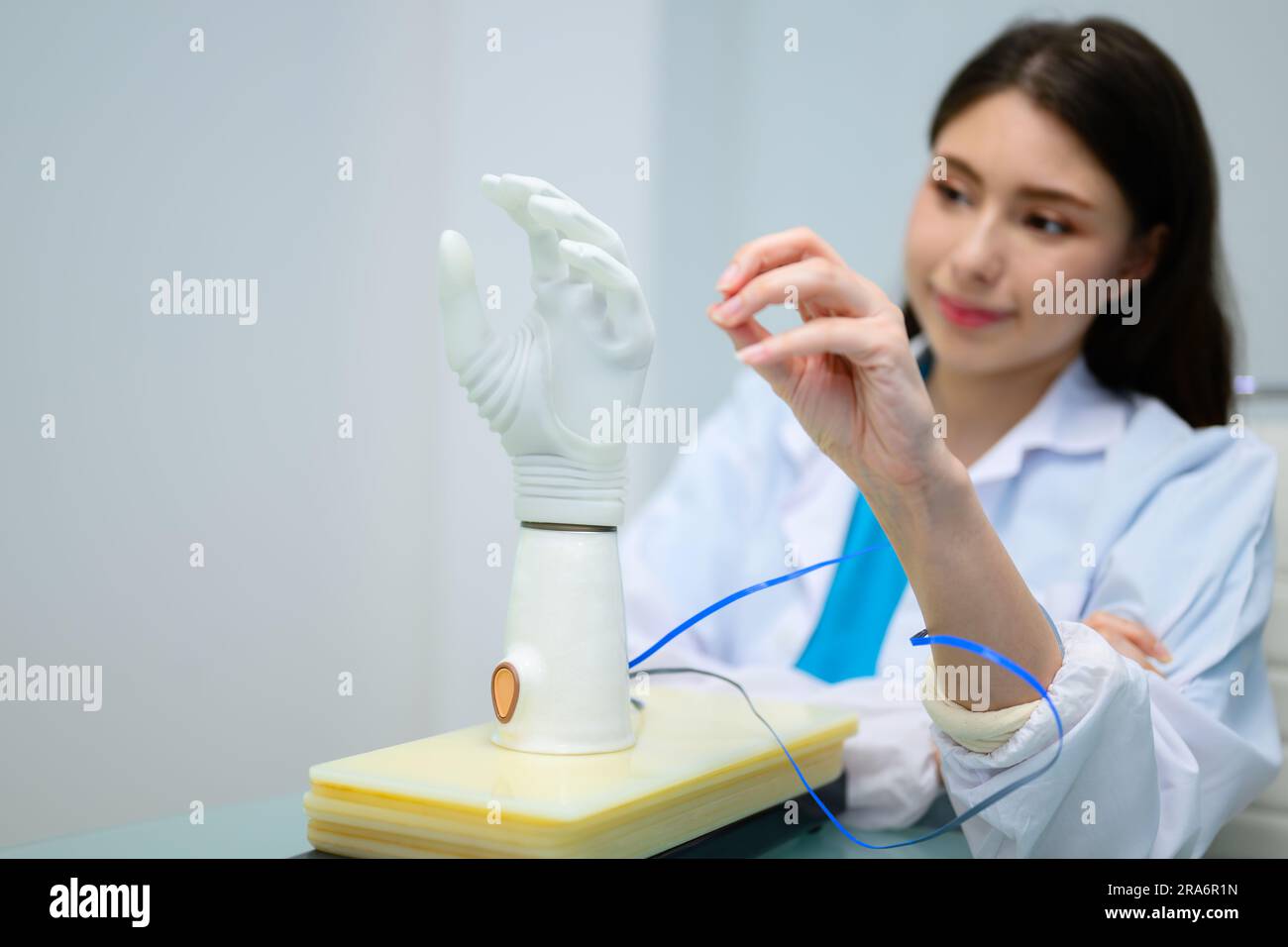 Technician testing robotic bionic arm at prosthetic manufacturing Stock ...