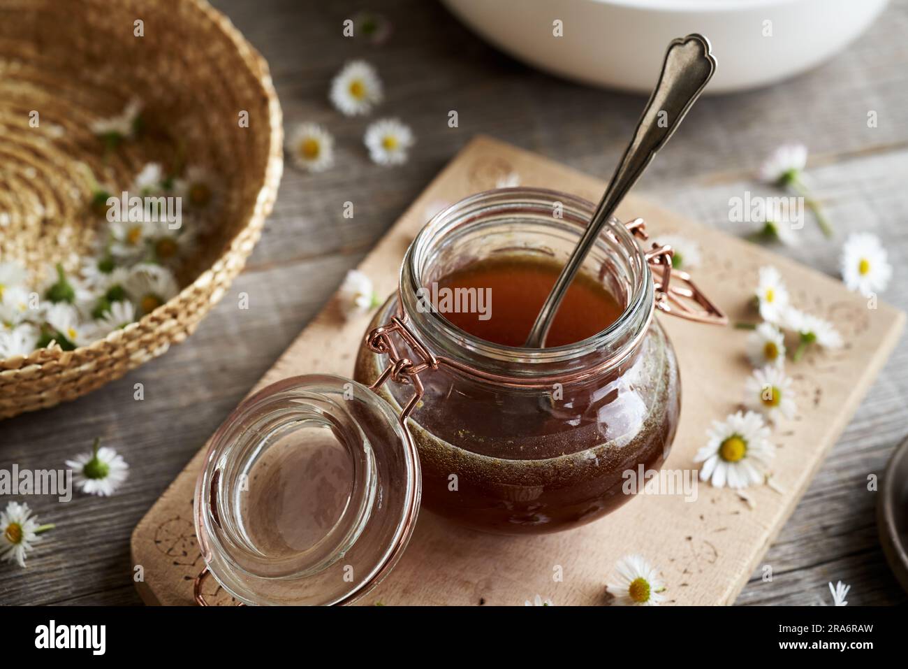 Homemade common daisy syrup for cough in a jar, with fresh flowers ...