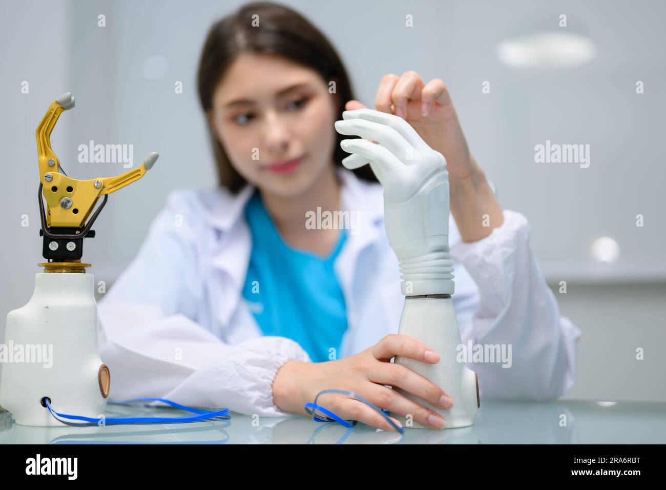 Technician testing robotic bionic arm at prosthetic manufacturing Stock ...