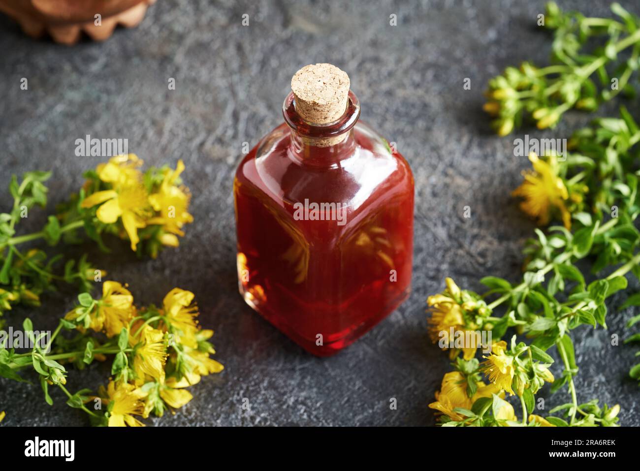 Homemade red oil made from fresh St. John's wort flowers in summer in a ...