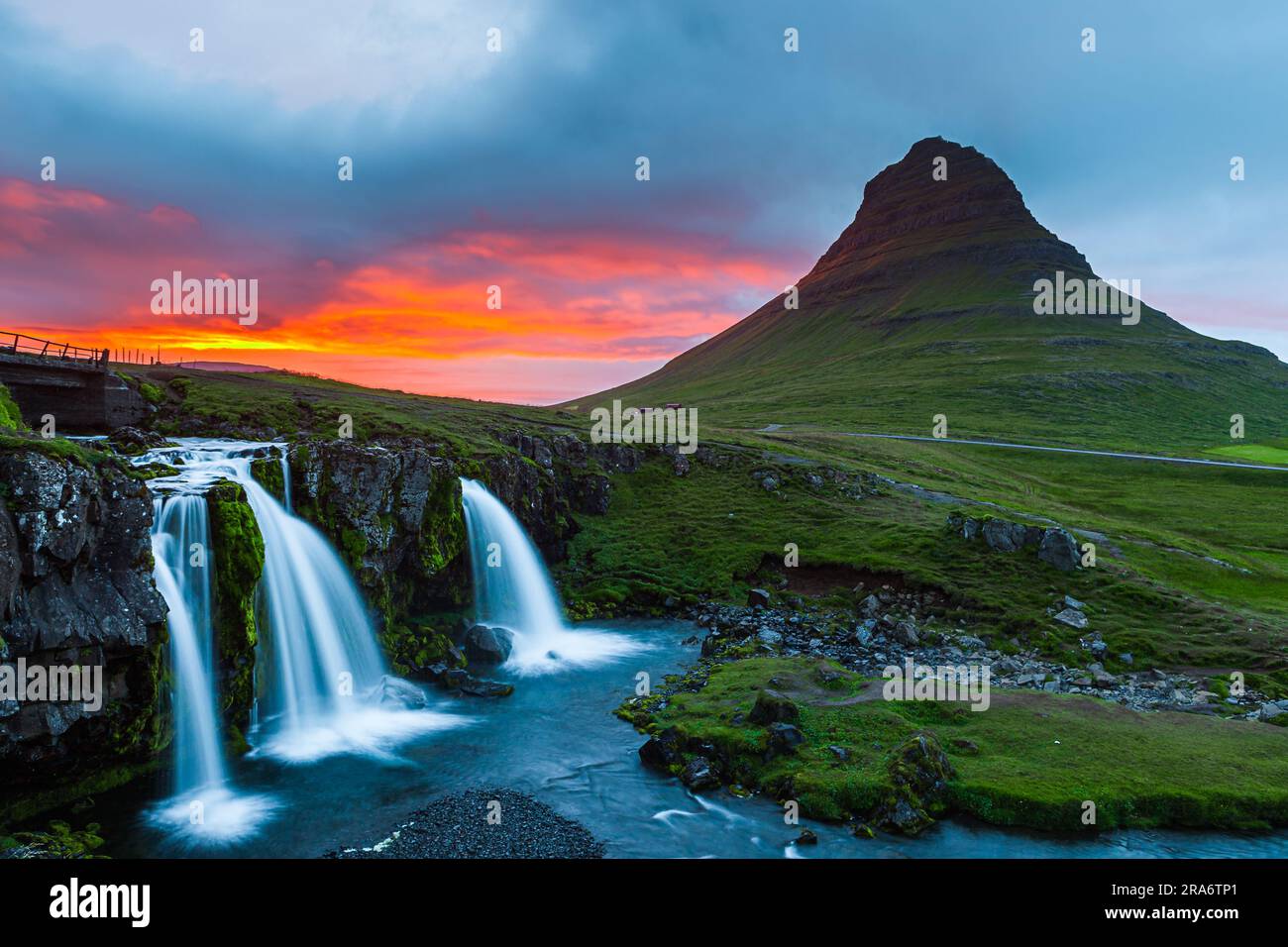 Kirkjufell mountain, Iceland. Beautiful sunset over Icelandic landscape with mountain and ...