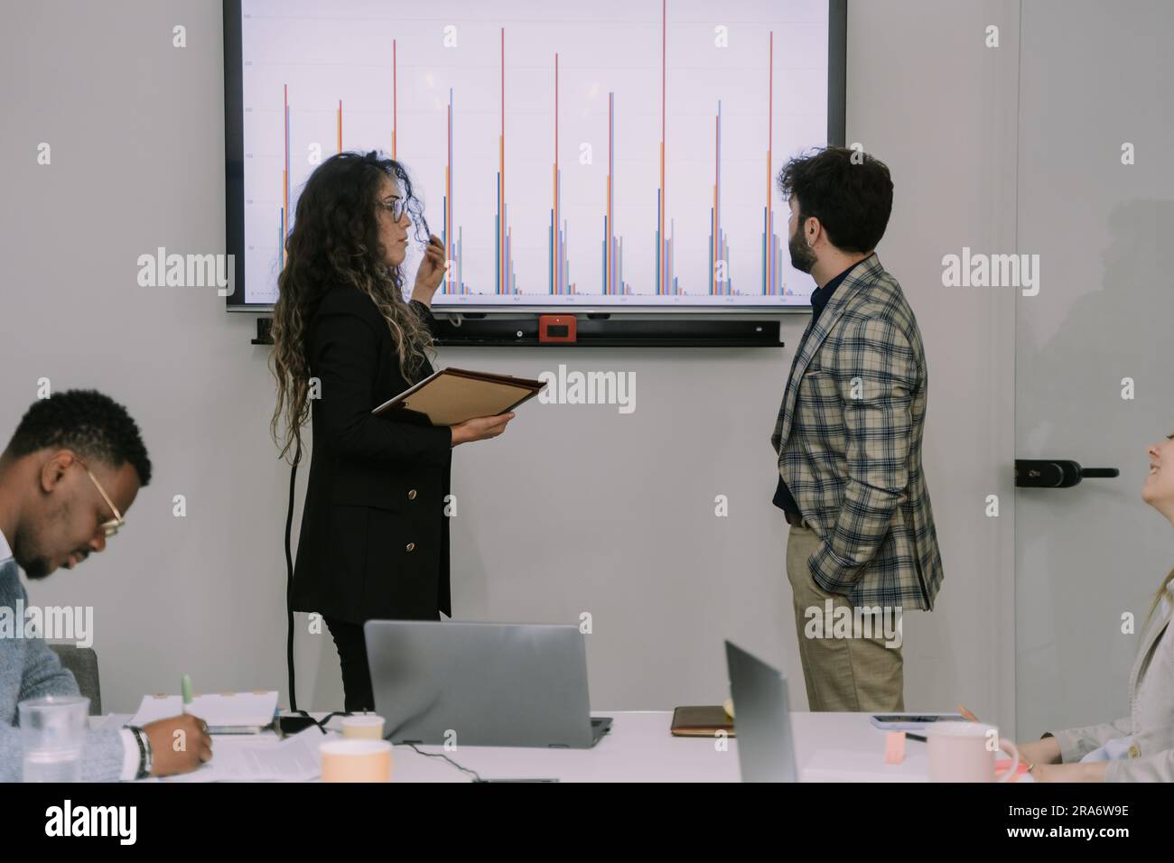 Beautiful Caucasian couple explaining graph charts of results because ...