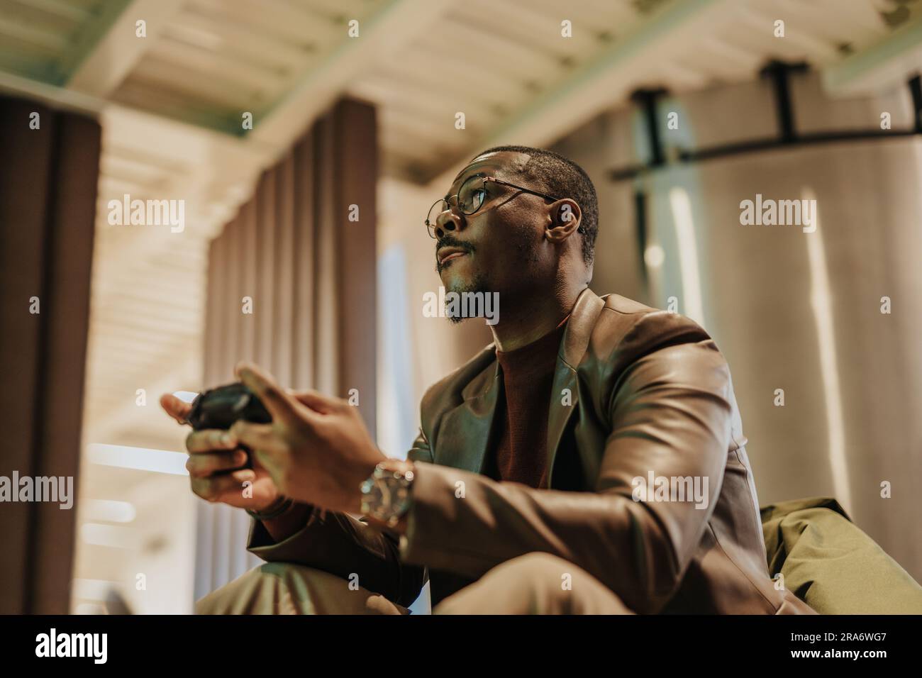 Happy man winning in video game playing with gaming console on the ...