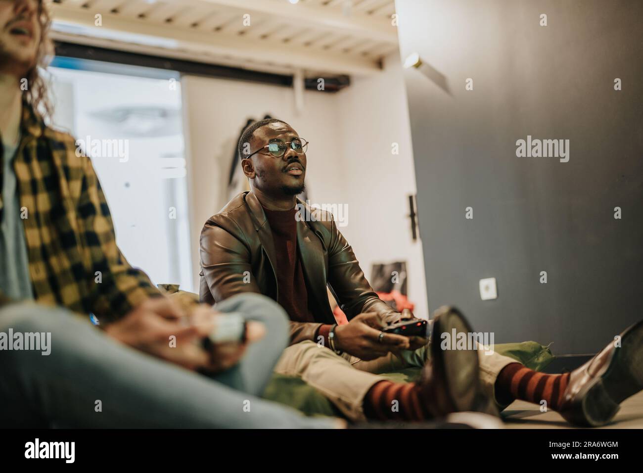 Group of friends playing hard with video games. young people sitting in ...