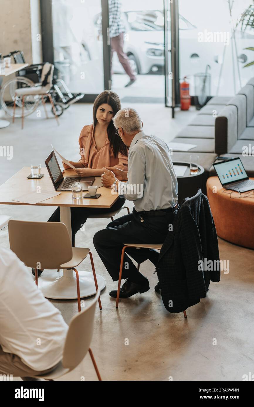 Mature businessman giving tips and tricks to his female employee for ...