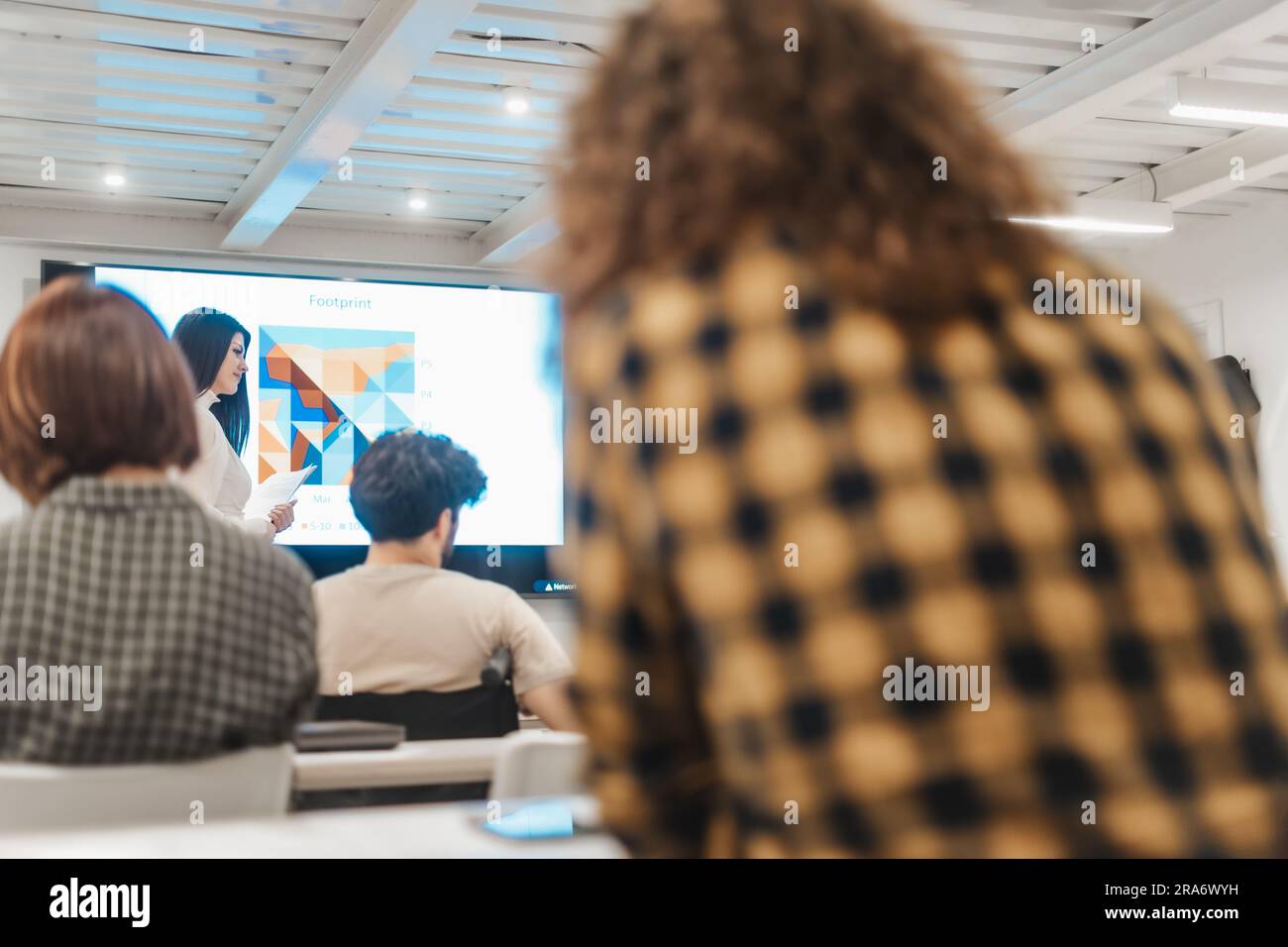 Classroom meeting and presentation. Young businesspeople working ...
