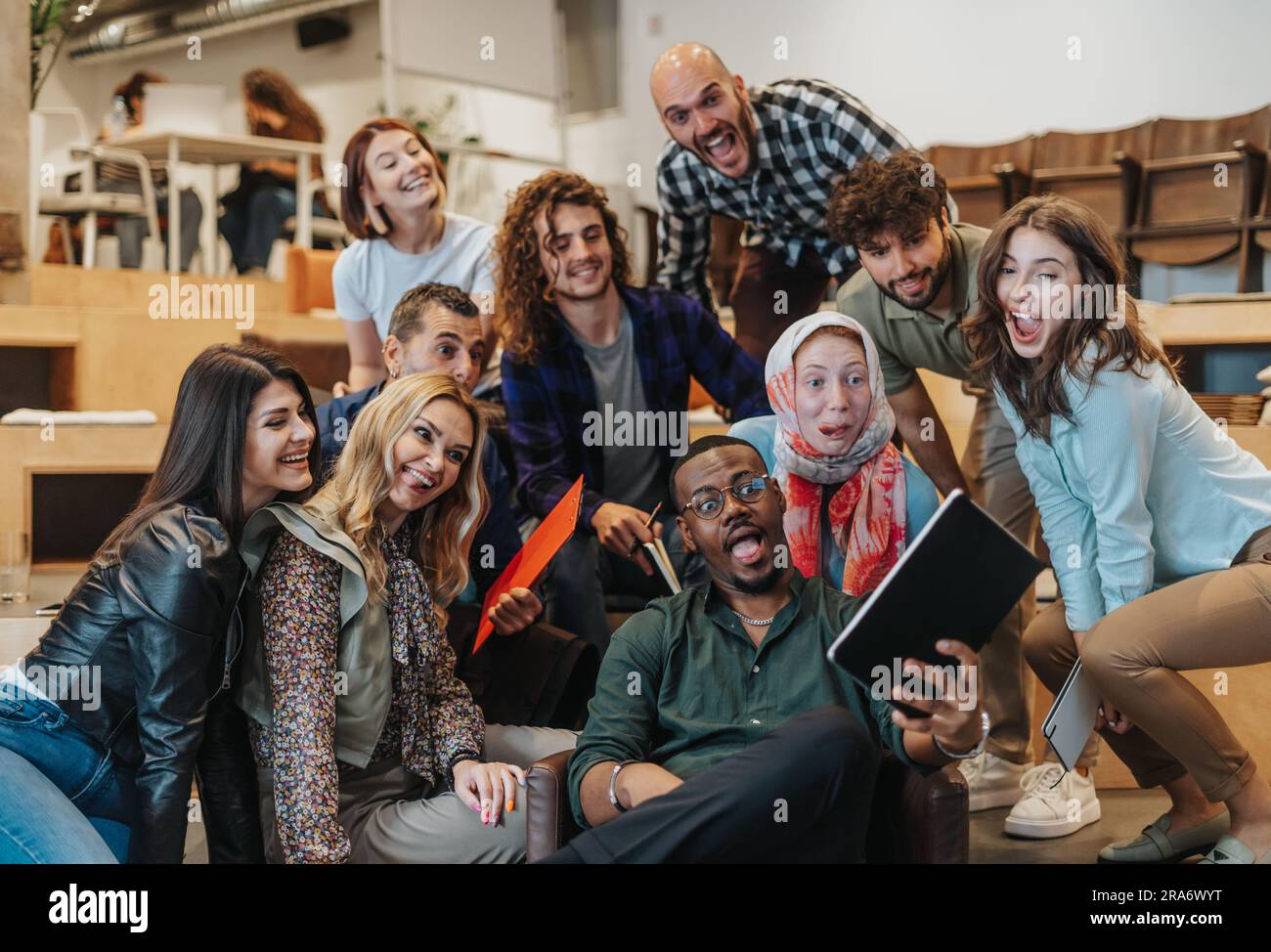 Happy, different aged, multiracial business team making faces while ...
