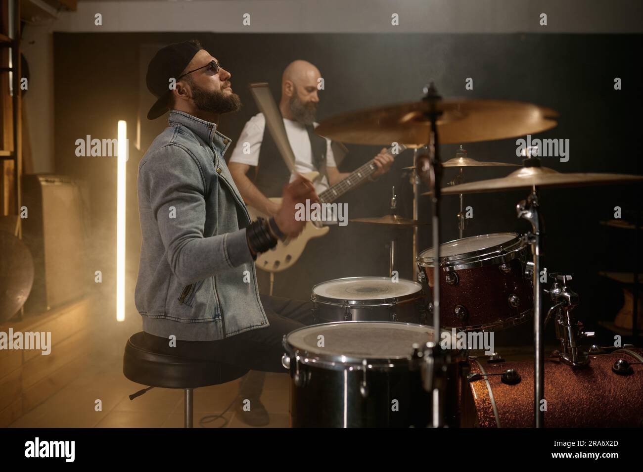 Rock band performance with focus on drummer beating music rhythm Stock ...