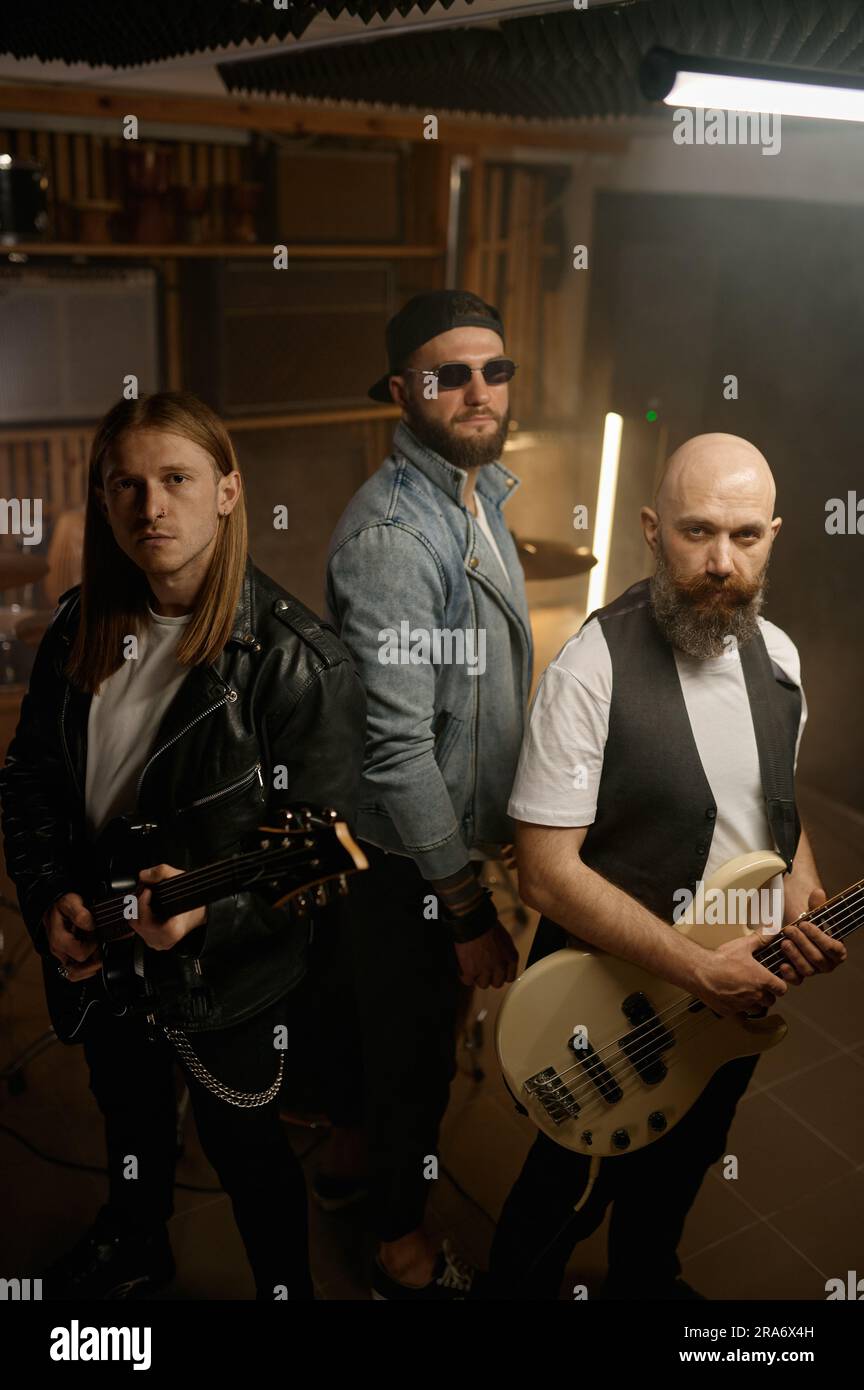 Rock band portrait with rockstar guitar player of different age Stock ...