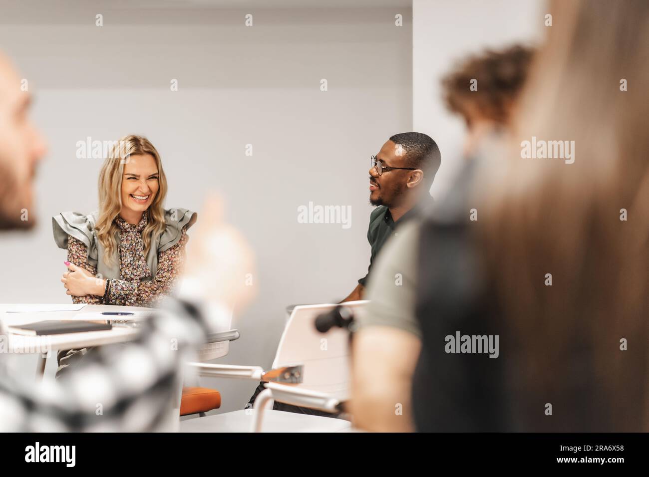 Multiracial business coworkers having fun conversation and laughing ...