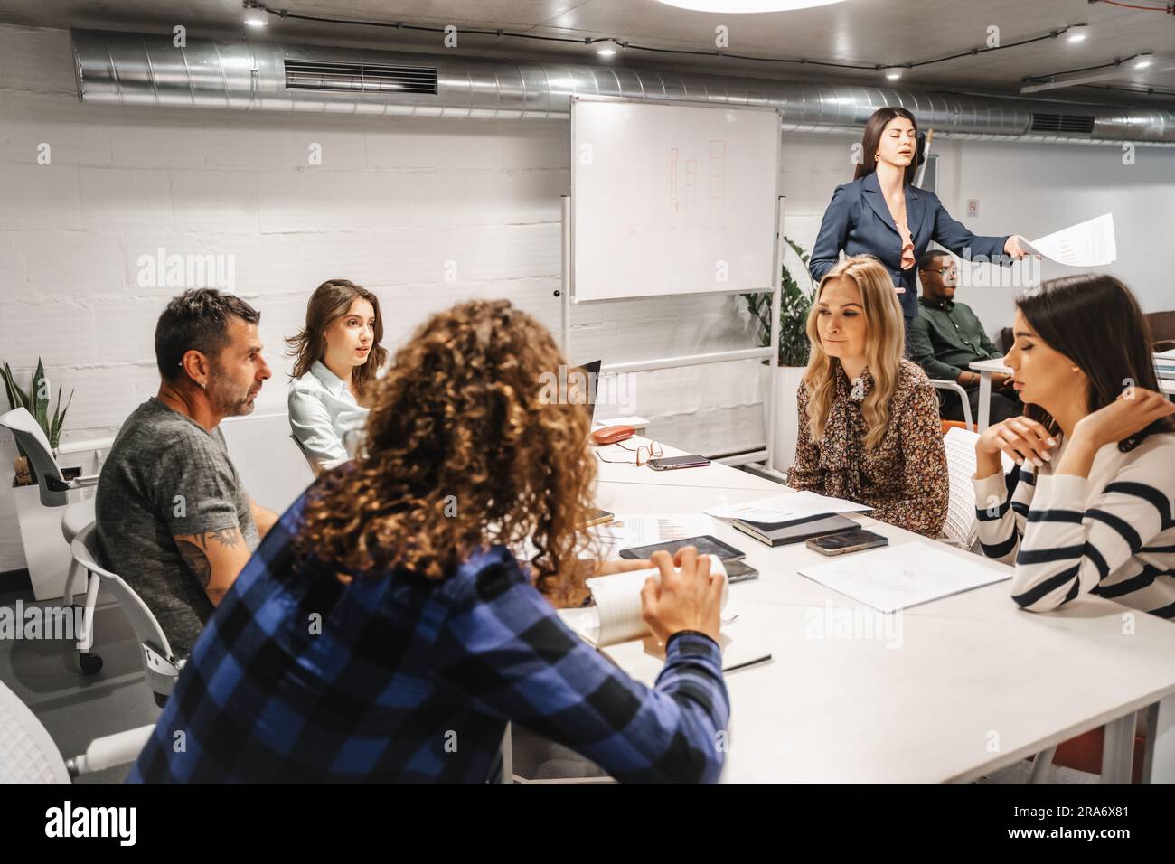 Inter-generational group of businesspeople having meeting at the office ...