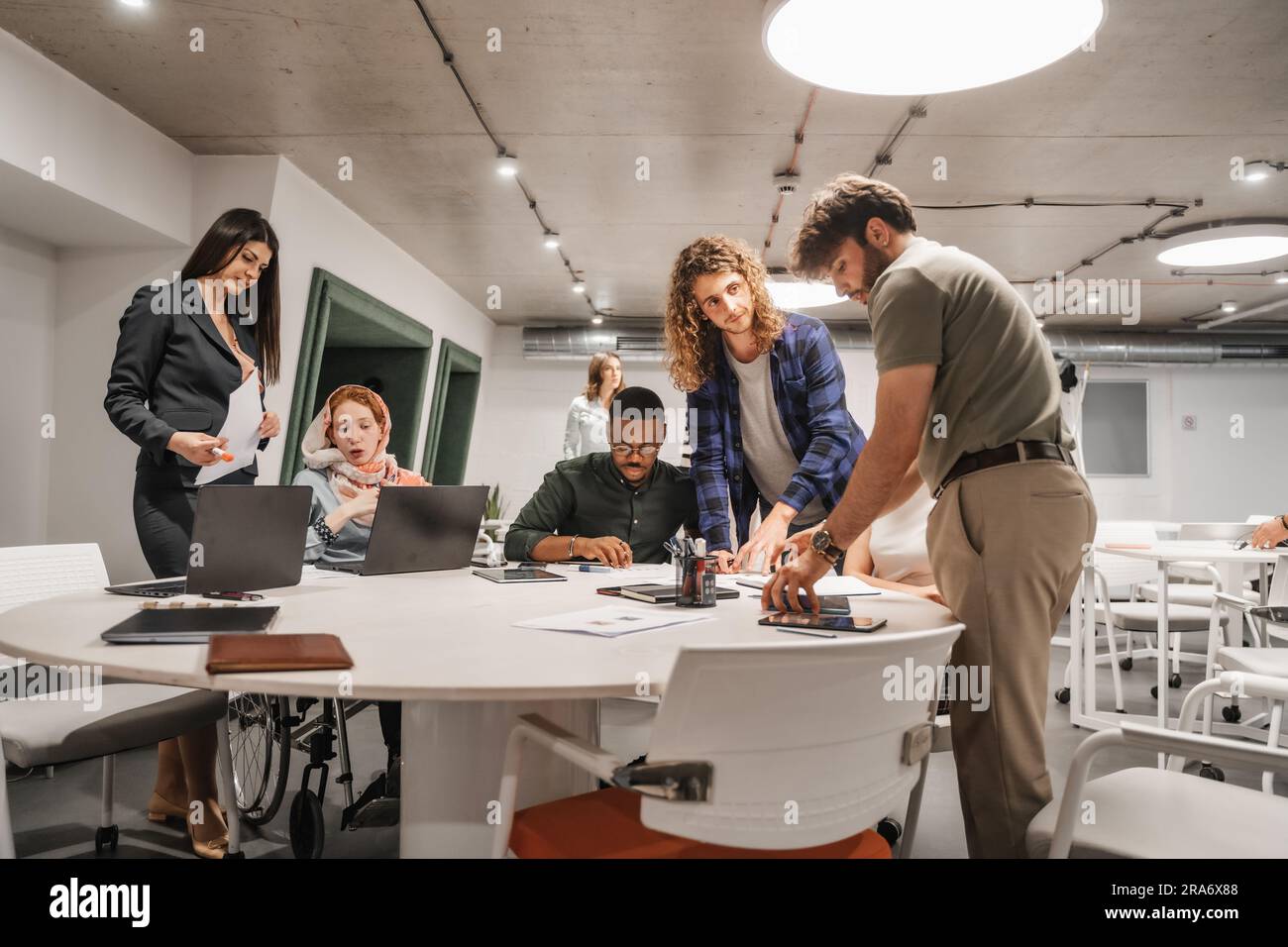 Young diverse employees working together in a multinational company ...