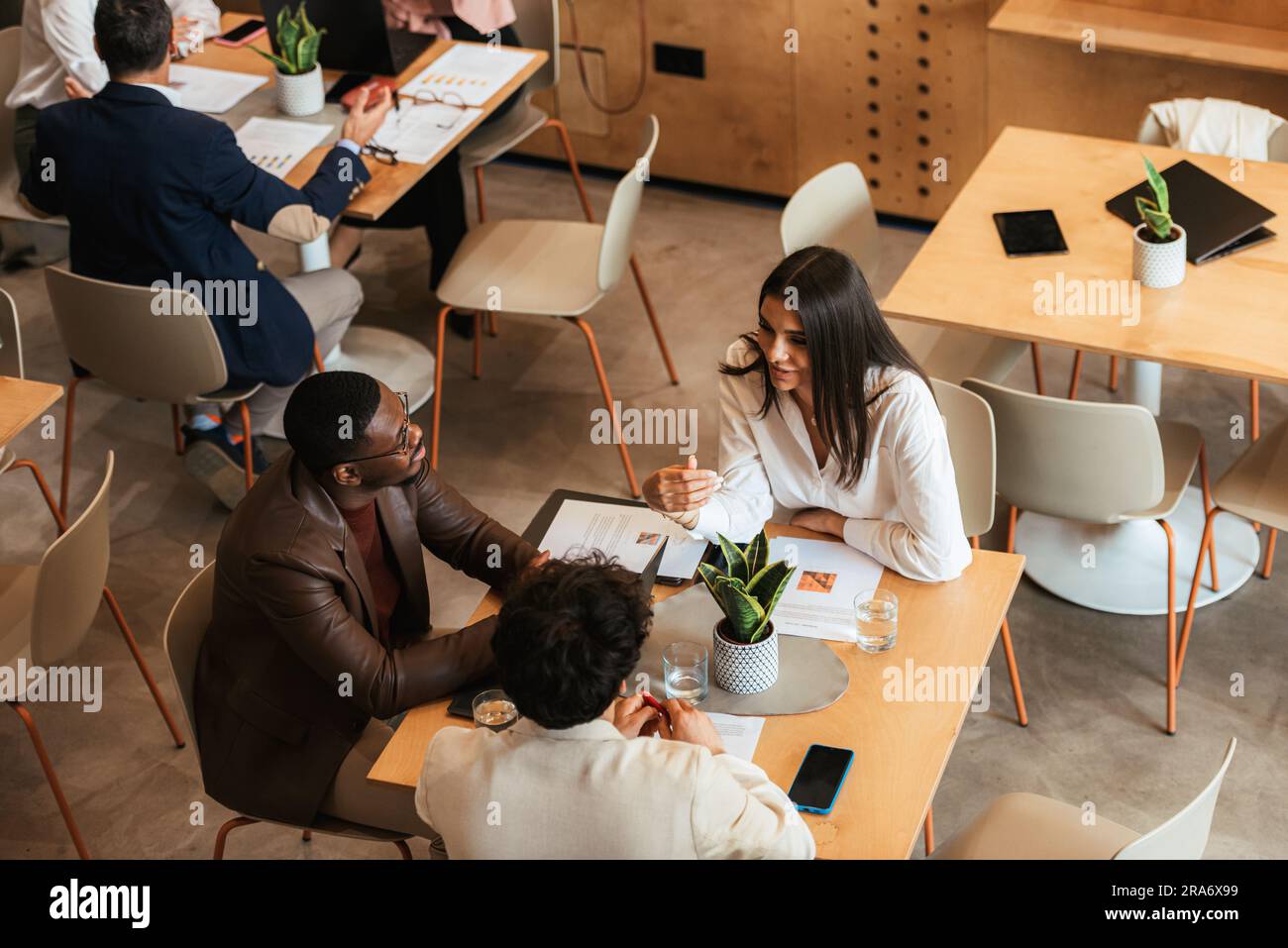 High view of businesspeople working and explaining something to each ...