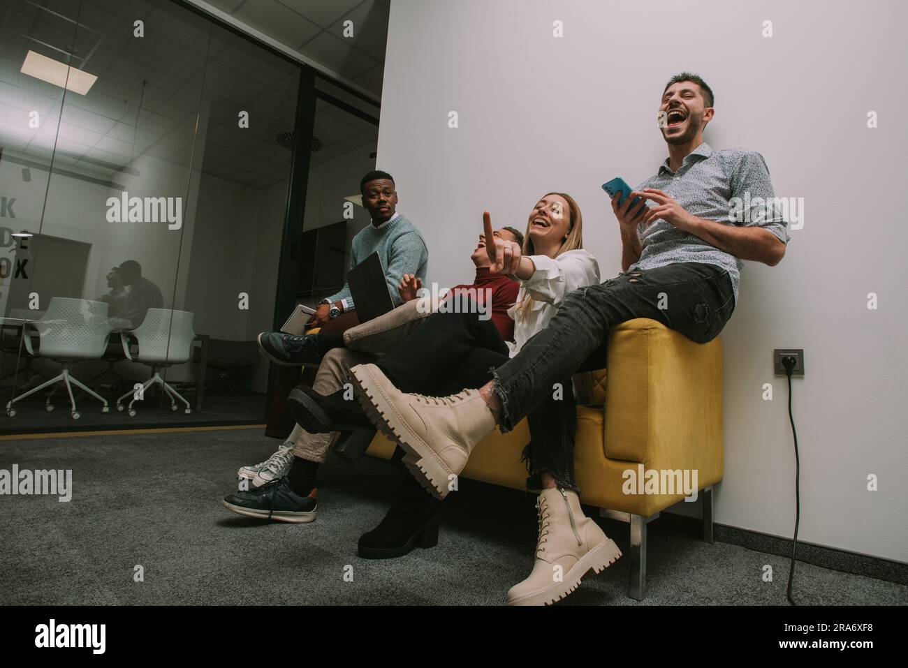 A scene of photographer joking with models while shooting business ...