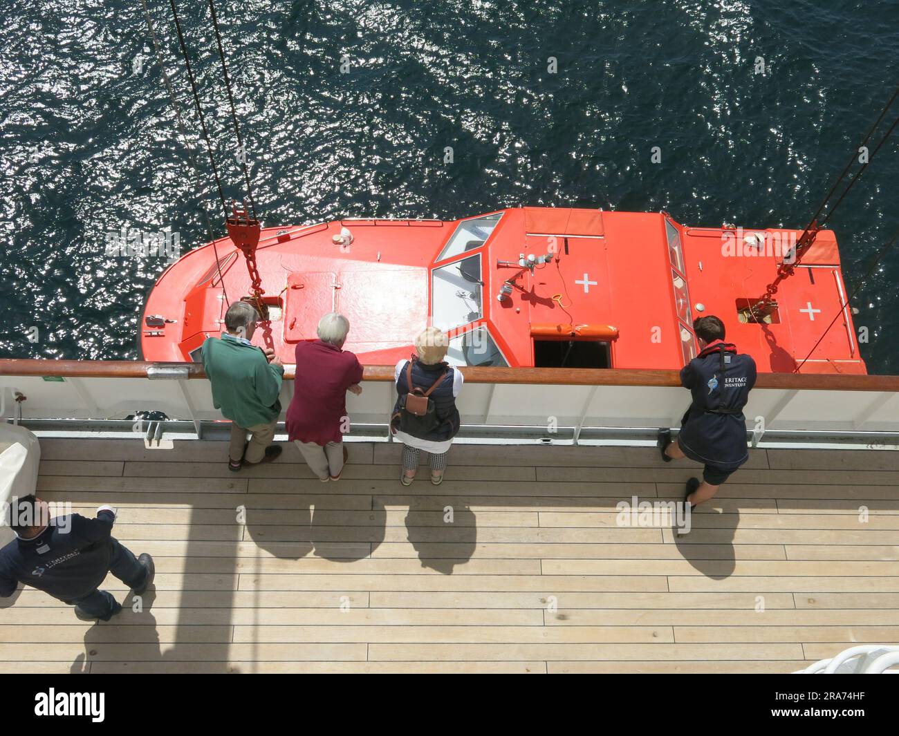 A crew member from the cruise ship "Heritage Adventurer" watches from ...