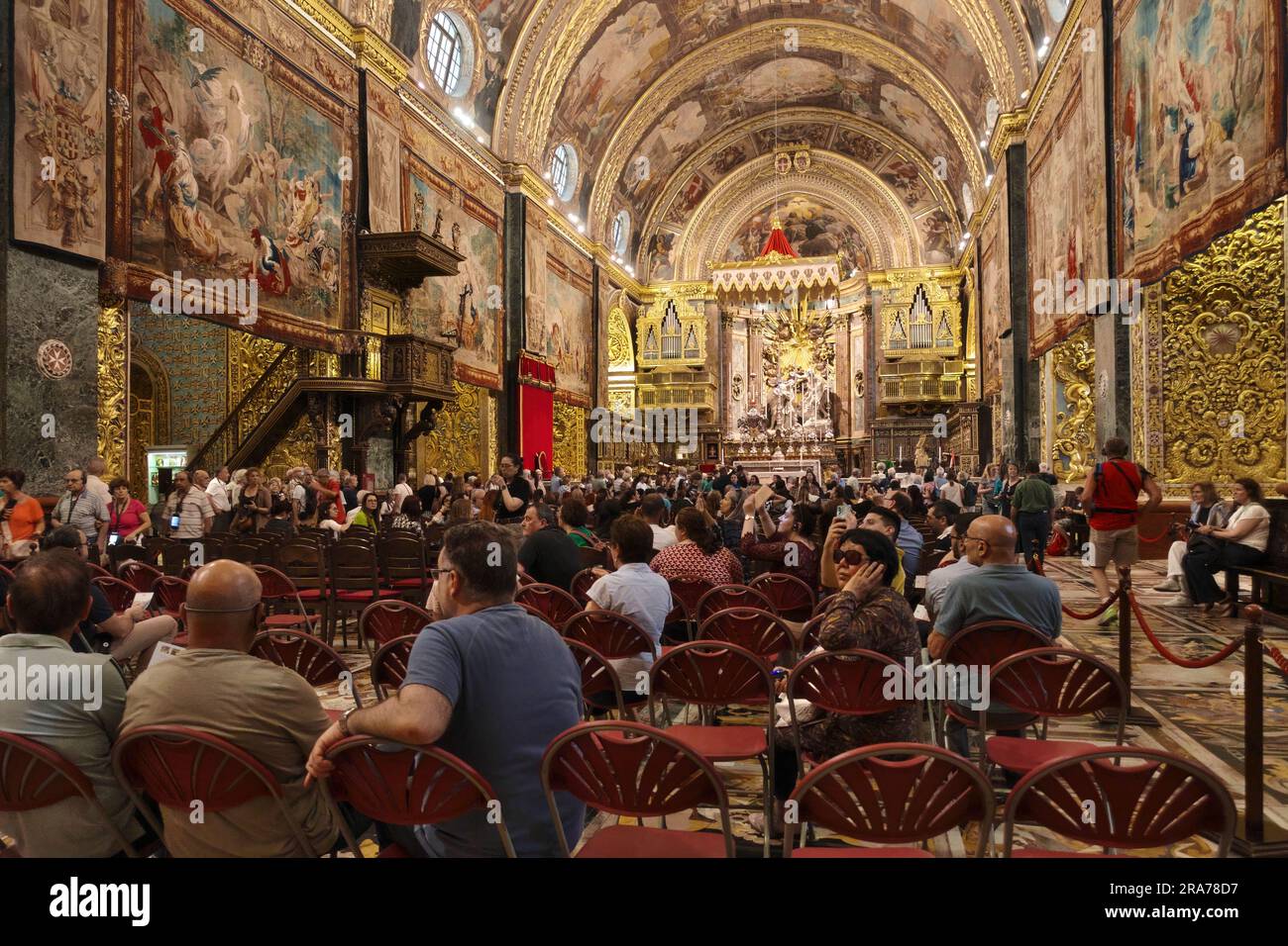 tourists crowds the interior main nave of St. John’s Co-Cathedral in ...