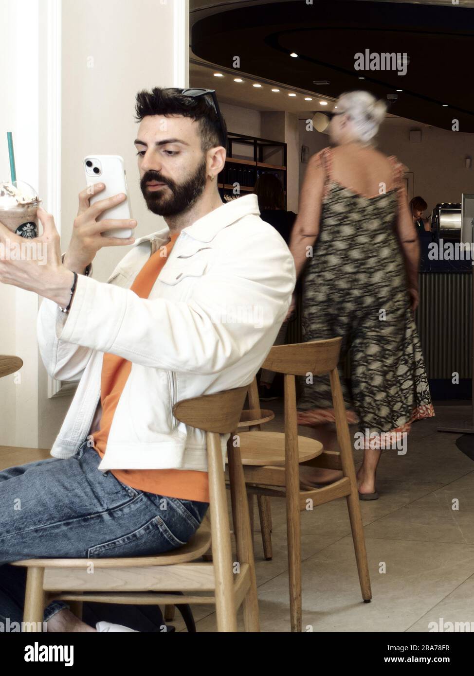 young man taking picture with phone in Republic Street, Valletta, Malta ...