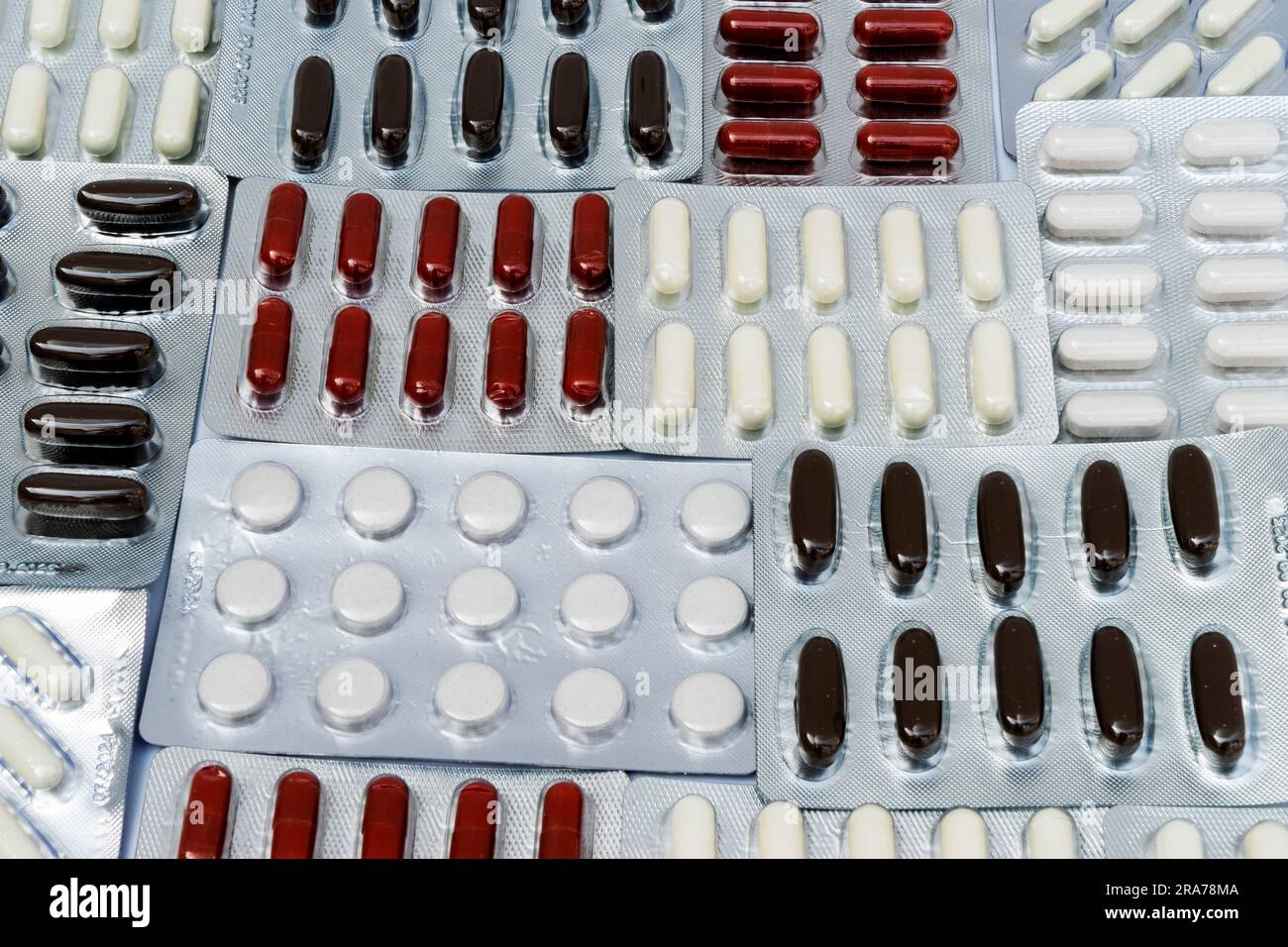 Abstract texture of blisters of multicolored round pills. Various ...