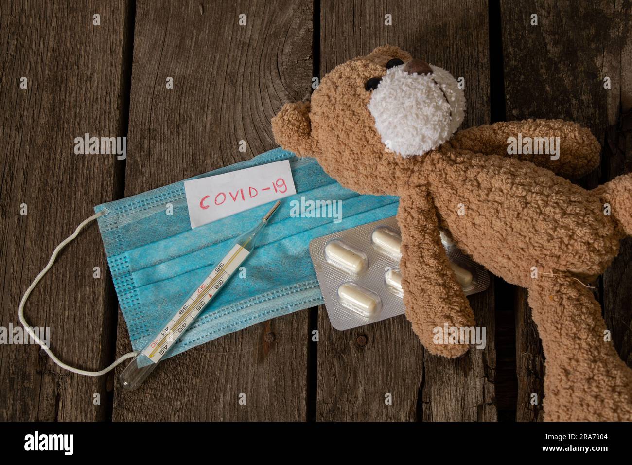 children's brown teddy bear with a thermometer tablets and a medical ...