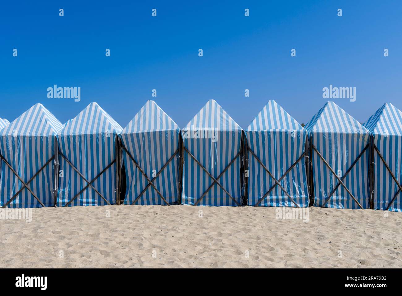 Blue changing huts on the beach in the summertime in Espinho town ...