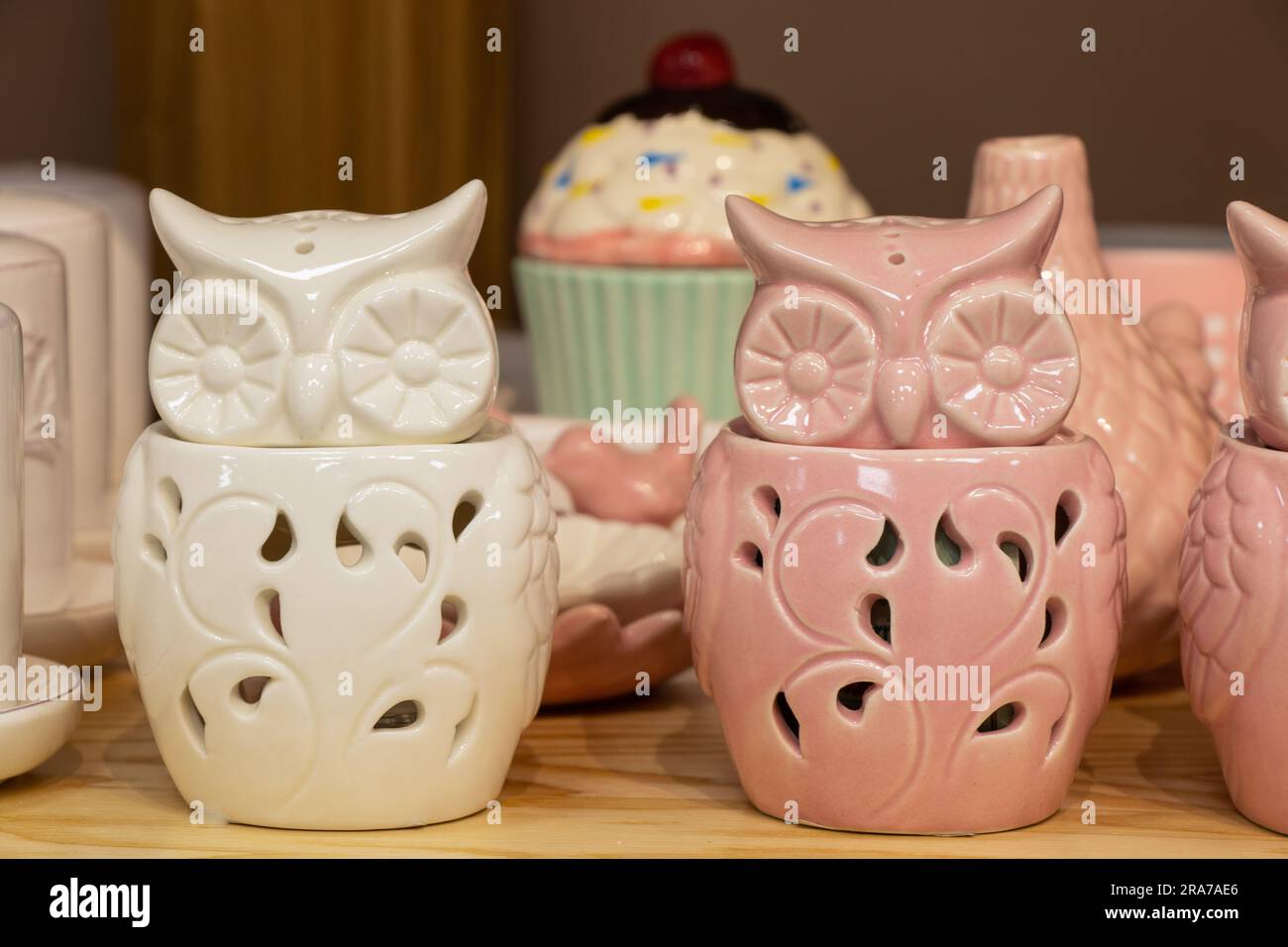 two glass vases in the shape of an owl stand on a shelf in a shop ...