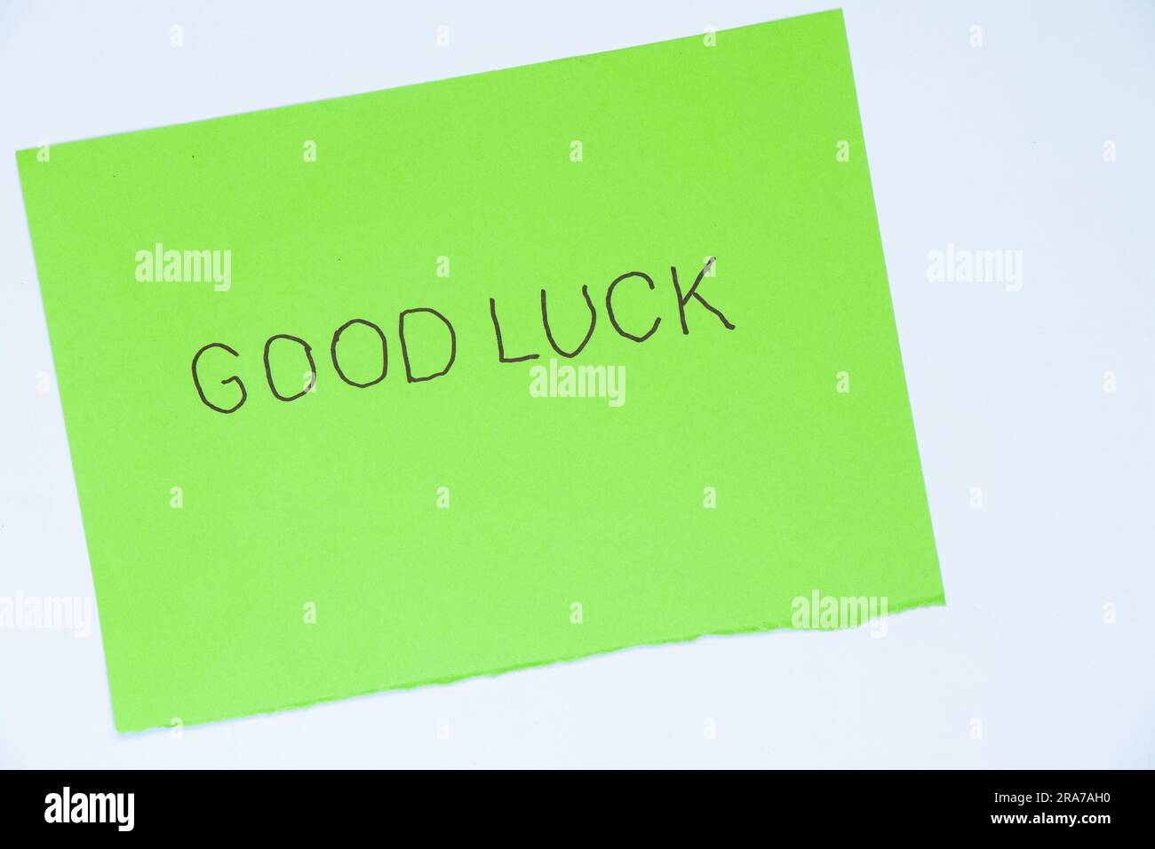 good luck english text on green sheet on white Stock Photo - Alamy