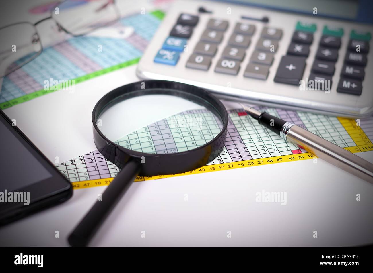 Business concept with magnifying glass, calculator and documents Stock ...