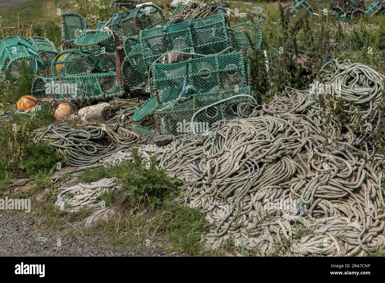 abandoned lobster pots and rope on the grass by the harbour Stock Photo ...