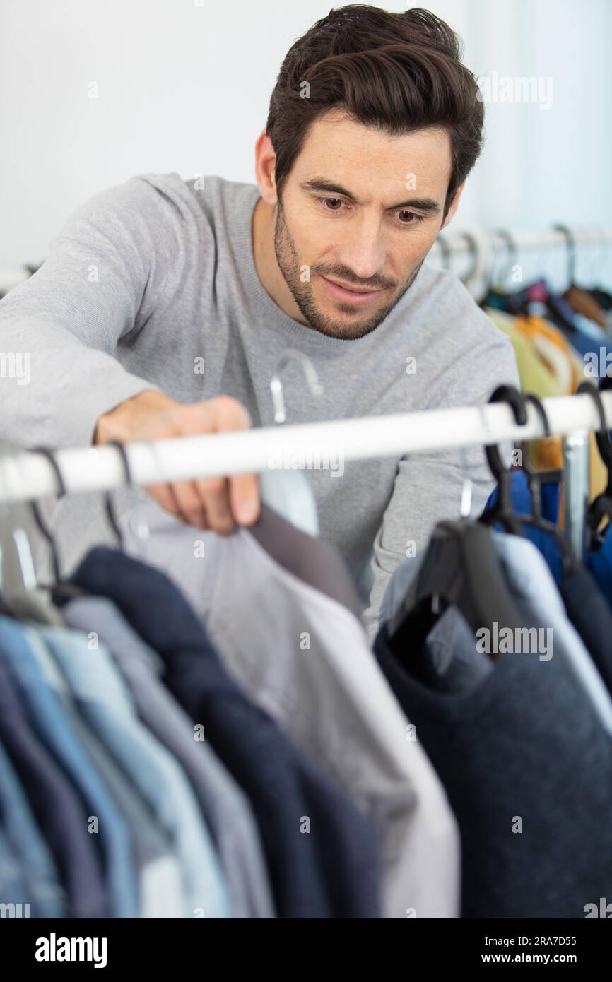 young man choosing shirt in the wardrobe Stock Photo - Alamy