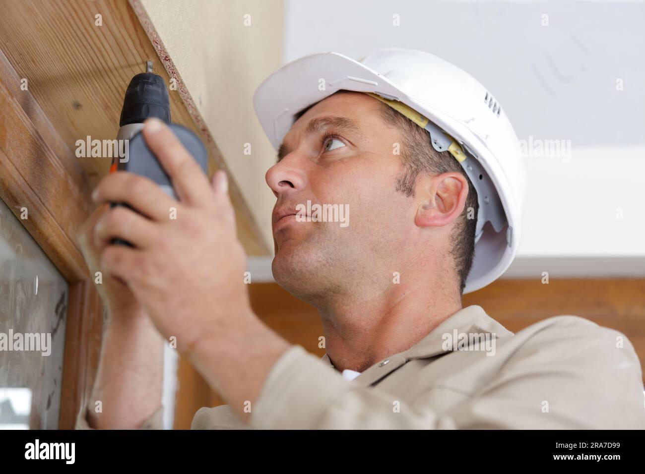 man builder installing a window Stock Photo - Alamy