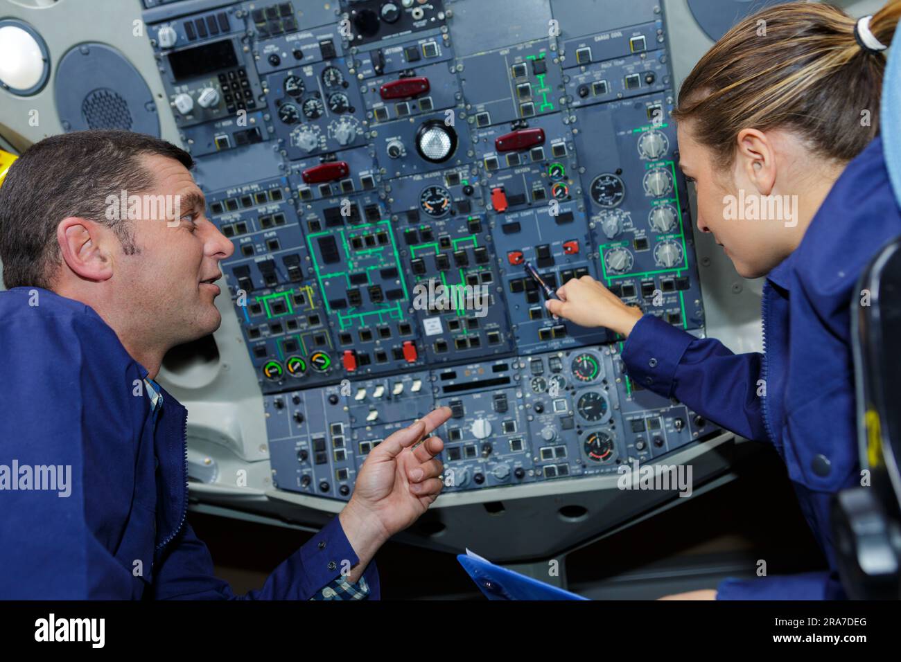 instructor teaching female engineer a cockpit Stock Photo - Alamy