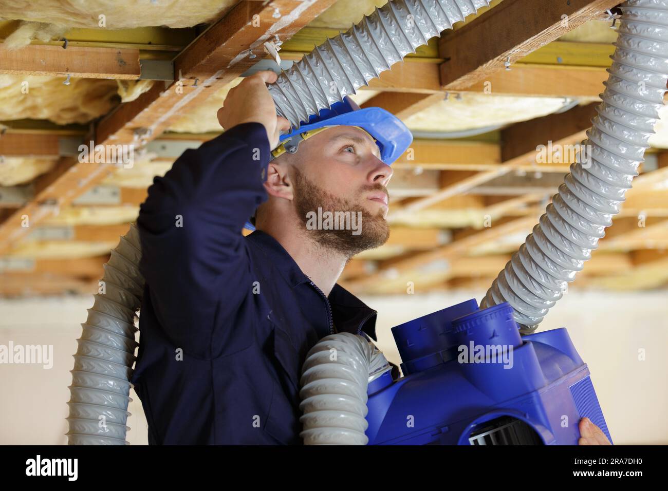 male builder working with pipes in the ceiling Stock Photo - Alamy
