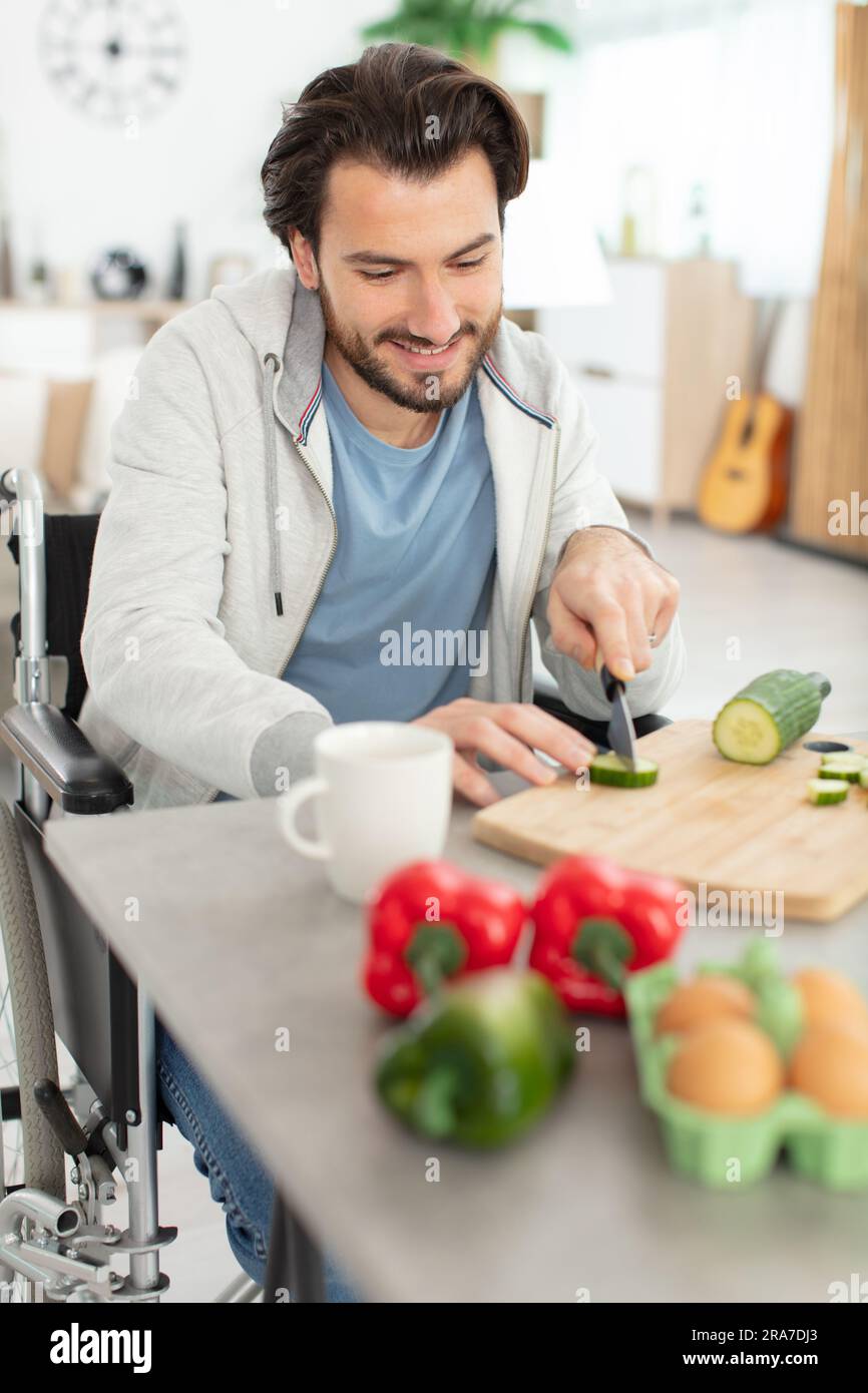 disabled man cooking at home sitting wheelchair Stock Photo - Alamy