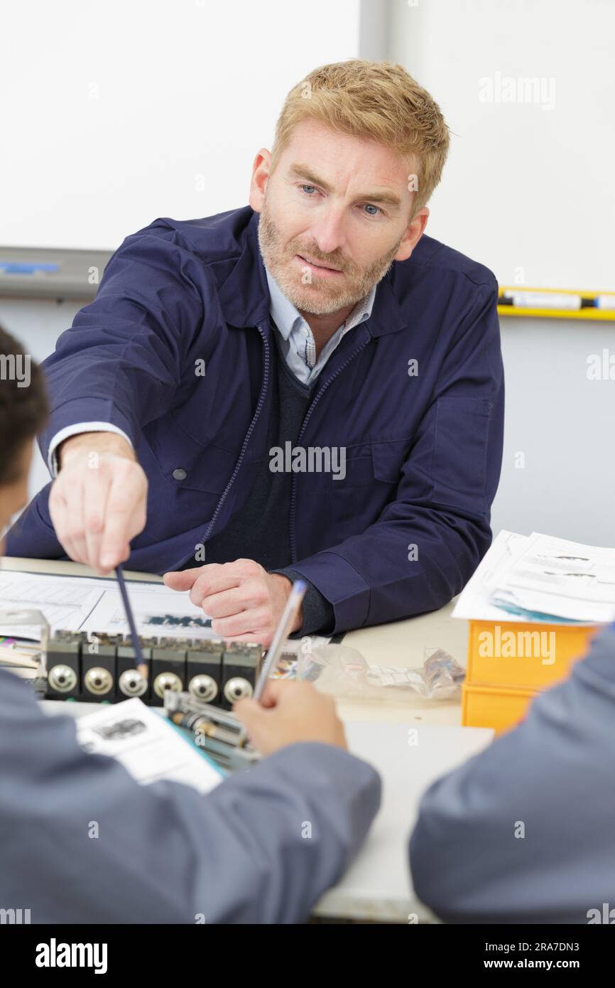 engineering apprentice presenting to group at whiteboard Stock Photo ...
